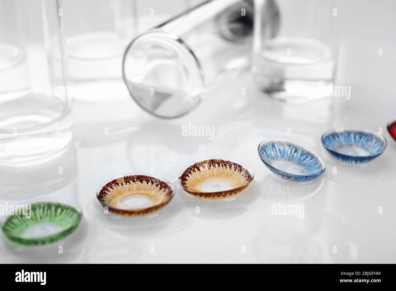 Contact lenses and bottles on white background Stock Photo - Alamy