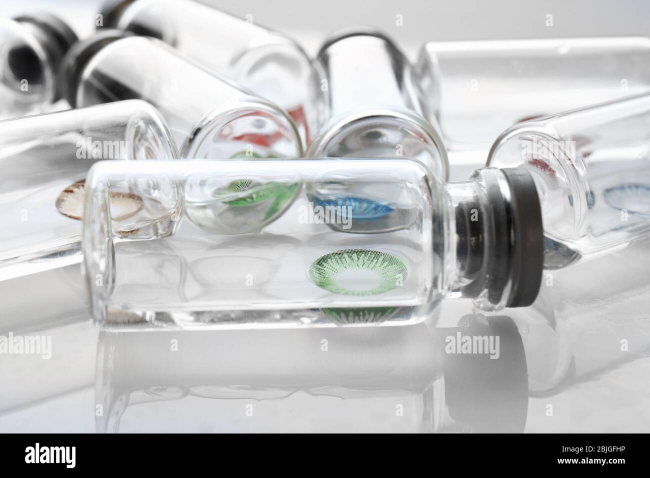 Bottles with contact lenses on white background Stock Photo - Alamy
