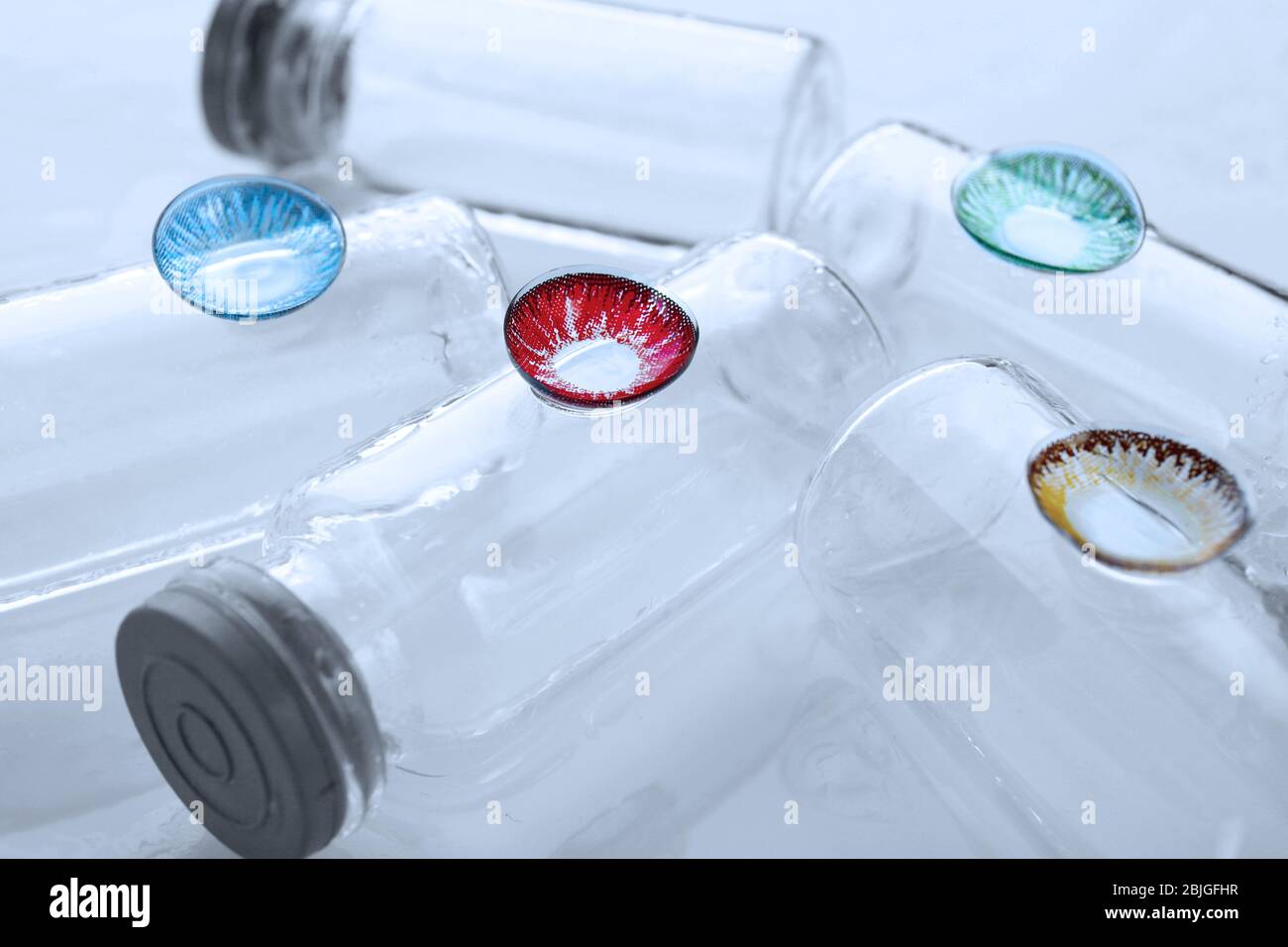 Bottles with contact lenses on white background Stock Photo - Alamy
