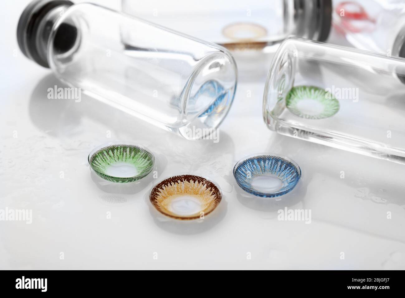 Contact lenses and bottles on white background Stock Photo - Alamy