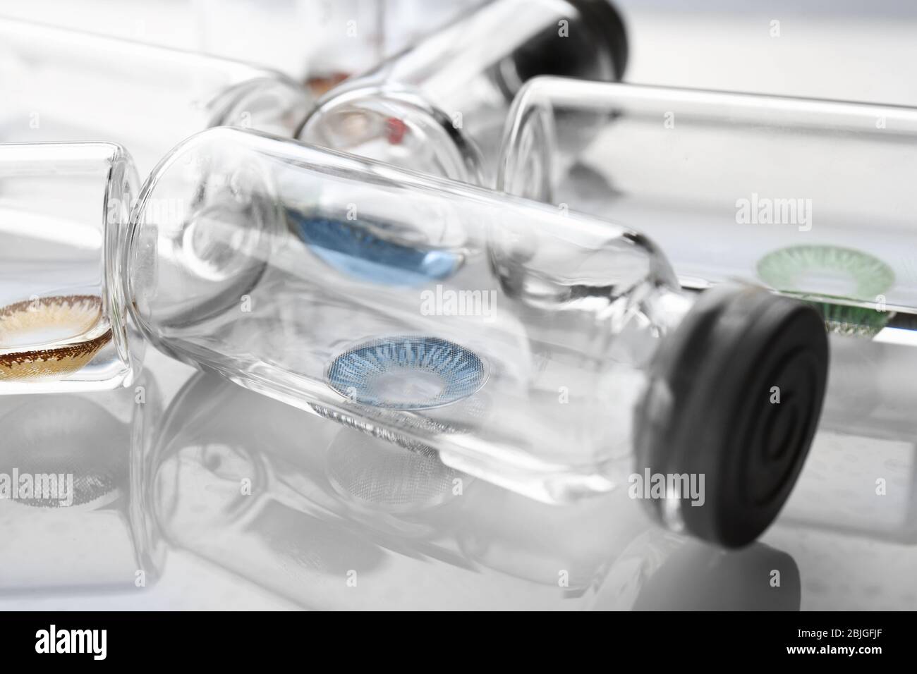 Bottles with contact lenses on white background Stock Photo - Alamy