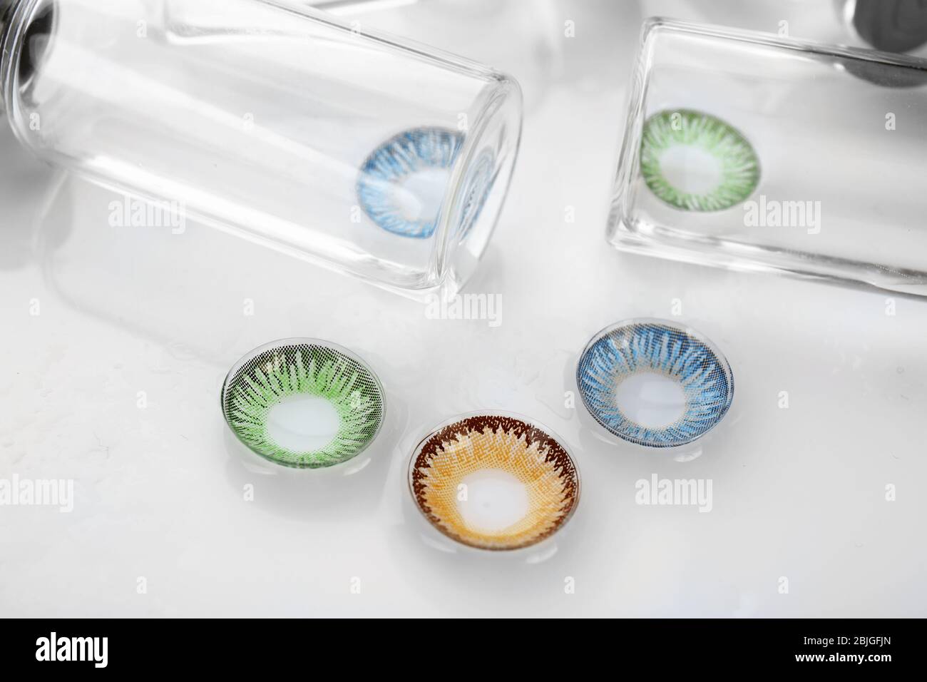Contact lenses and bottles on white background Stock Photo - Alamy