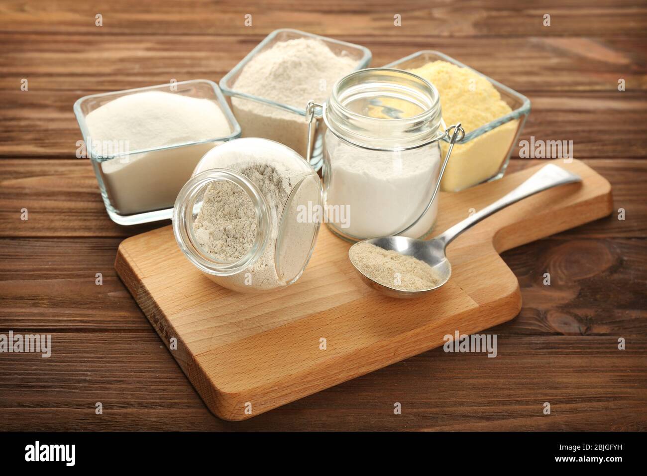 Composition with different types of flour on wooden table Stock Photo ...