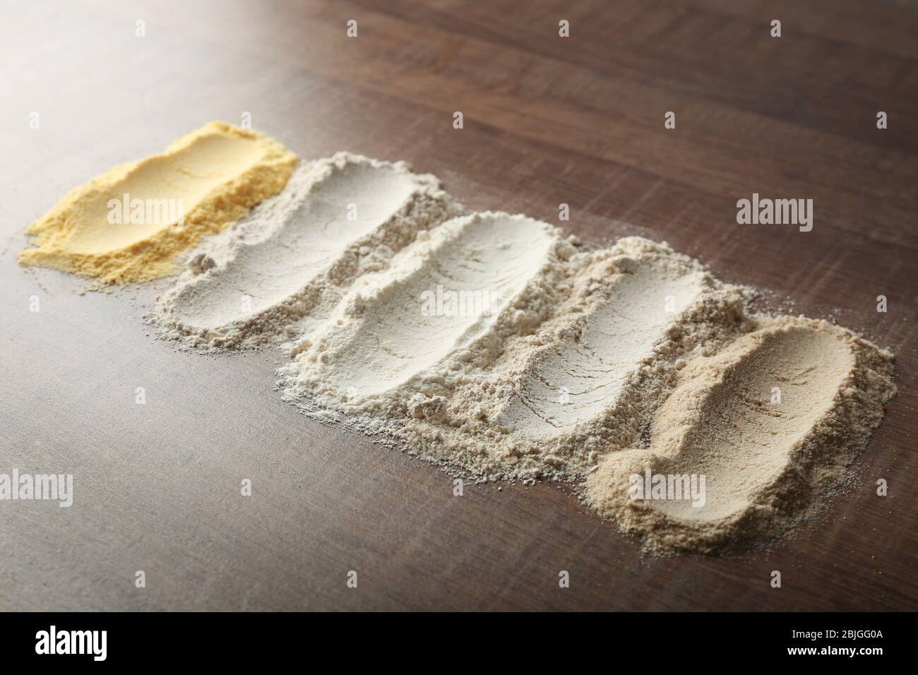 Composition with different types of flour on wooden table Stock Photo ...