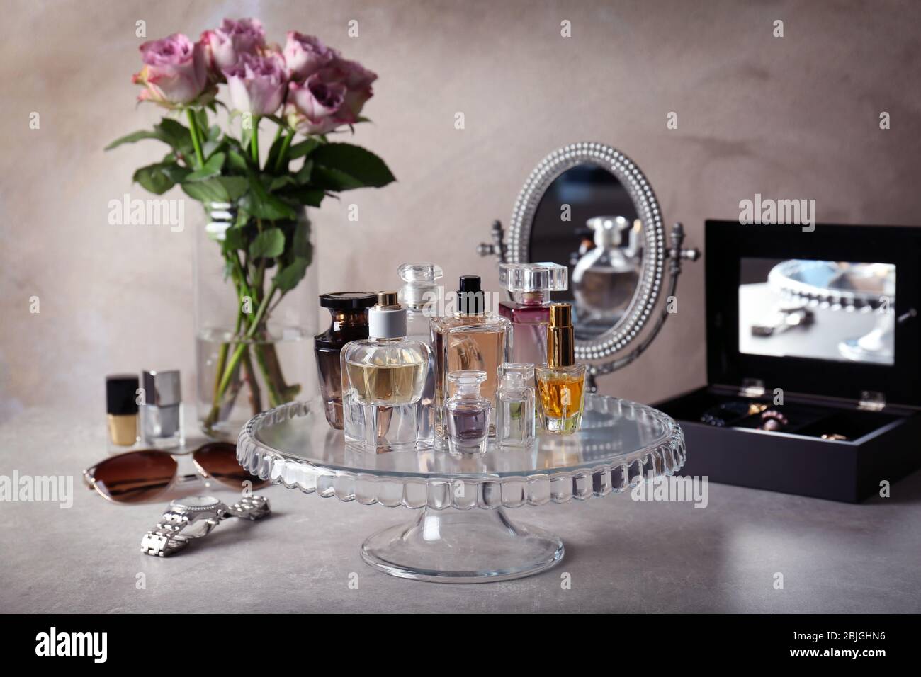 Stand with bottles of perfume on table Stock Photo - Alamy