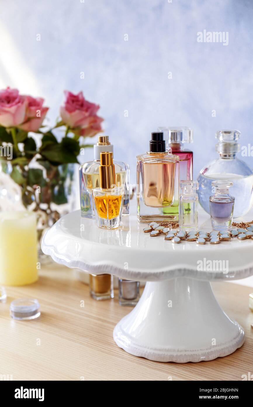 Stand with bottles of perfume on table Stock Photo - Alamy