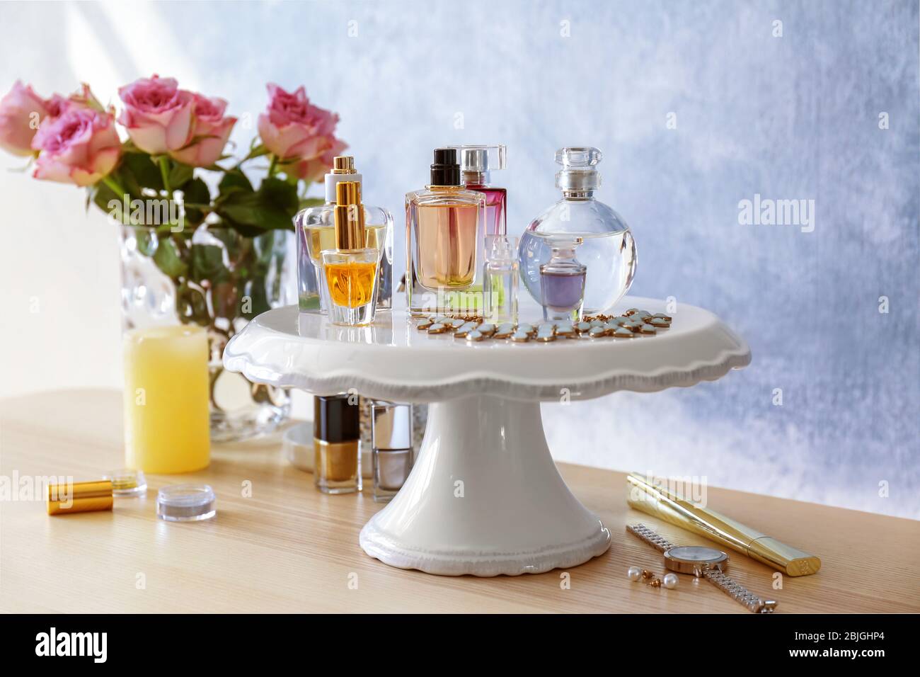 Stand with bottles of perfume on table Stock Photo - Alamy