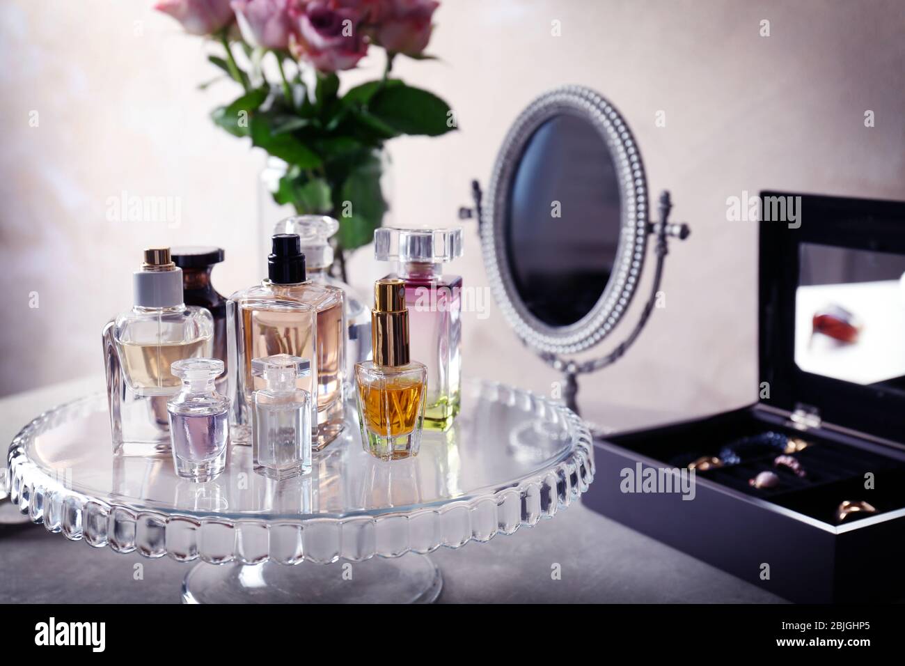 Stand with bottles of perfume on table Stock Photo - Alamy