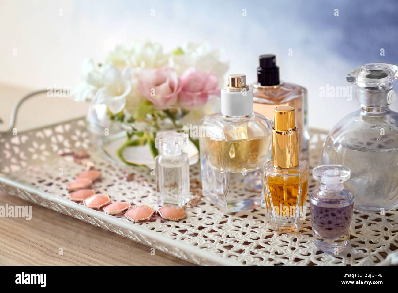 Tray with bottles of perfume on table Stock Photo - Alamy
