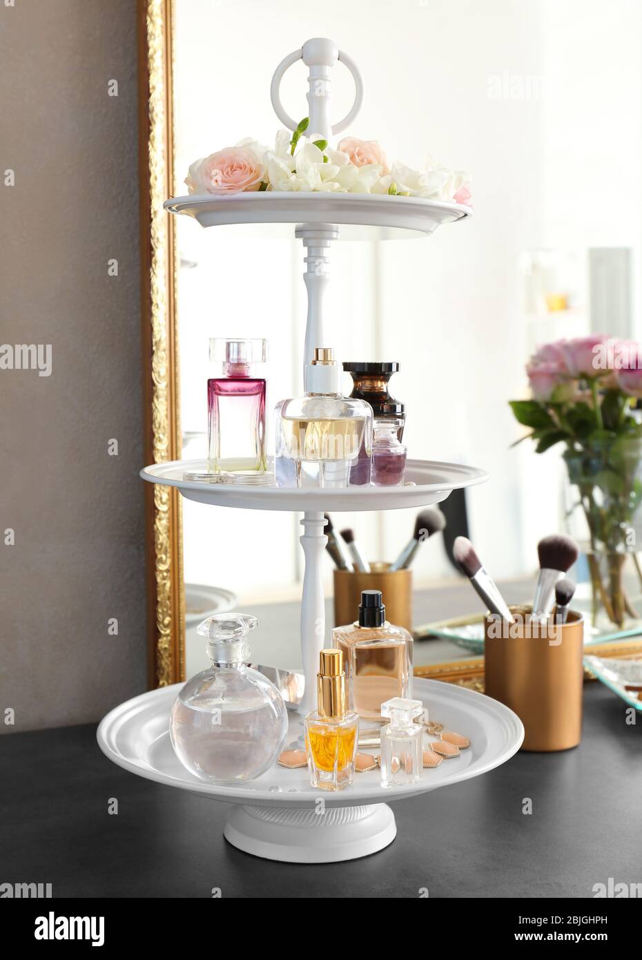 Stand with bottles of perfume on table Stock Photo - Alamy