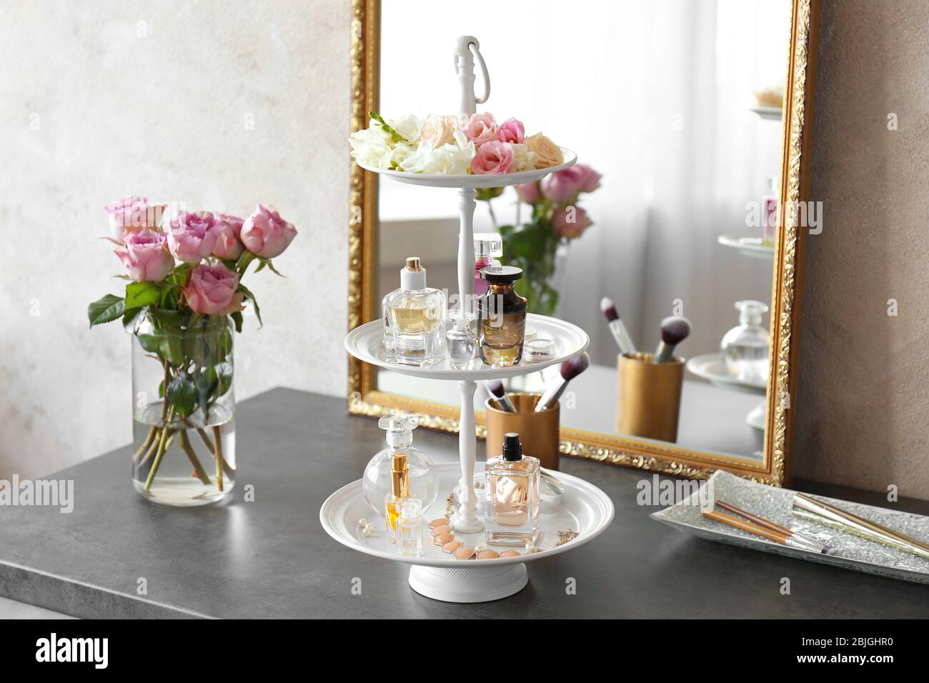 Stand with bottles of perfume on table Stock Photo - Alamy