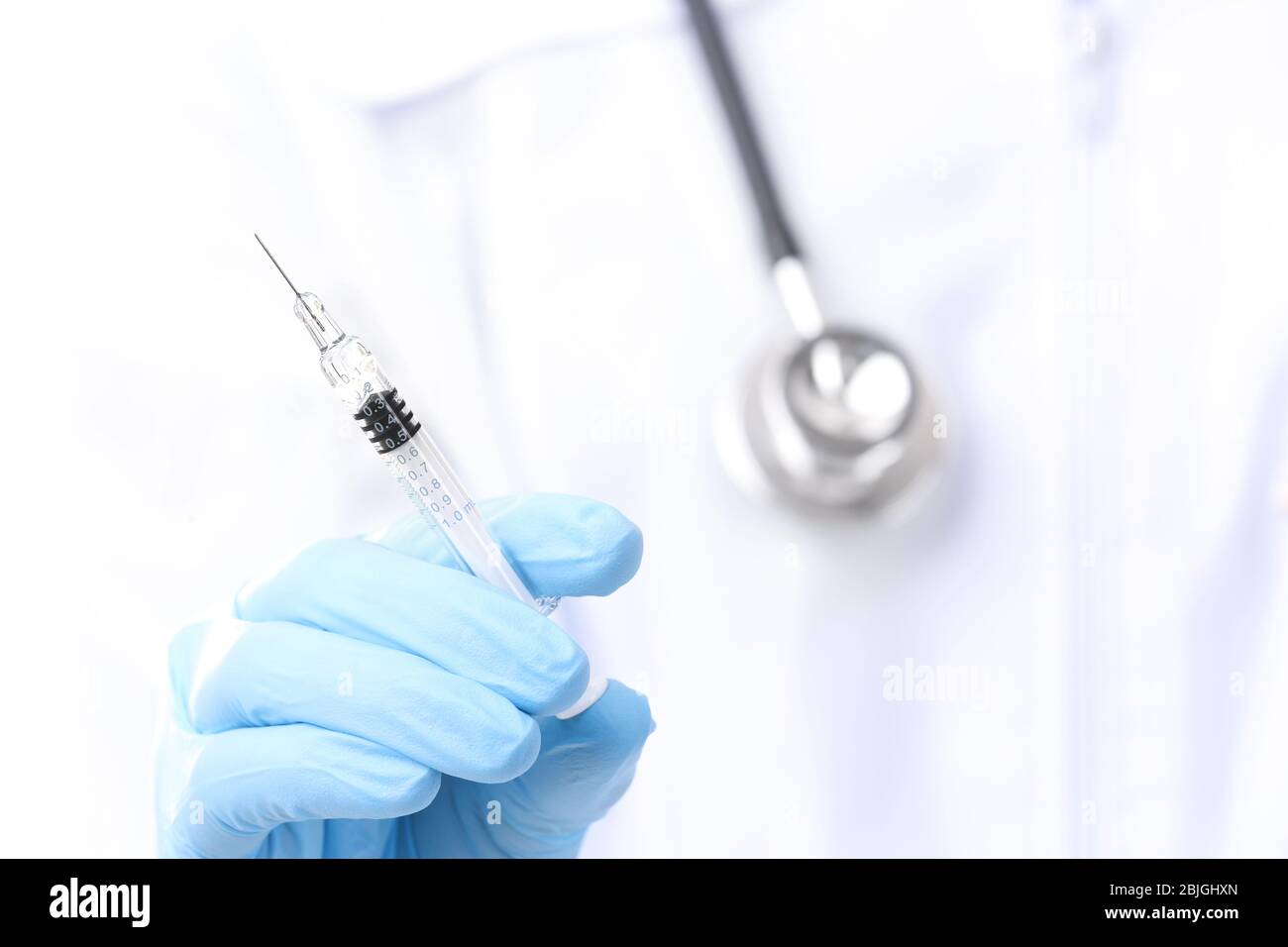 Doctor with syringe, closeup Stock Photo - Alamy