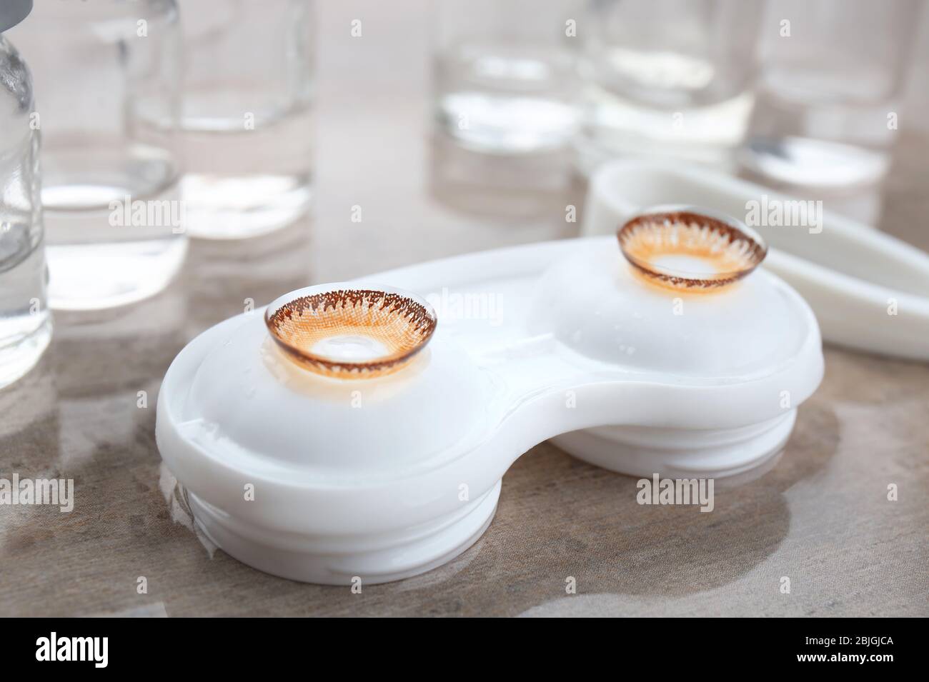 Container with color contact lenses on table Stock Photo - Alamy