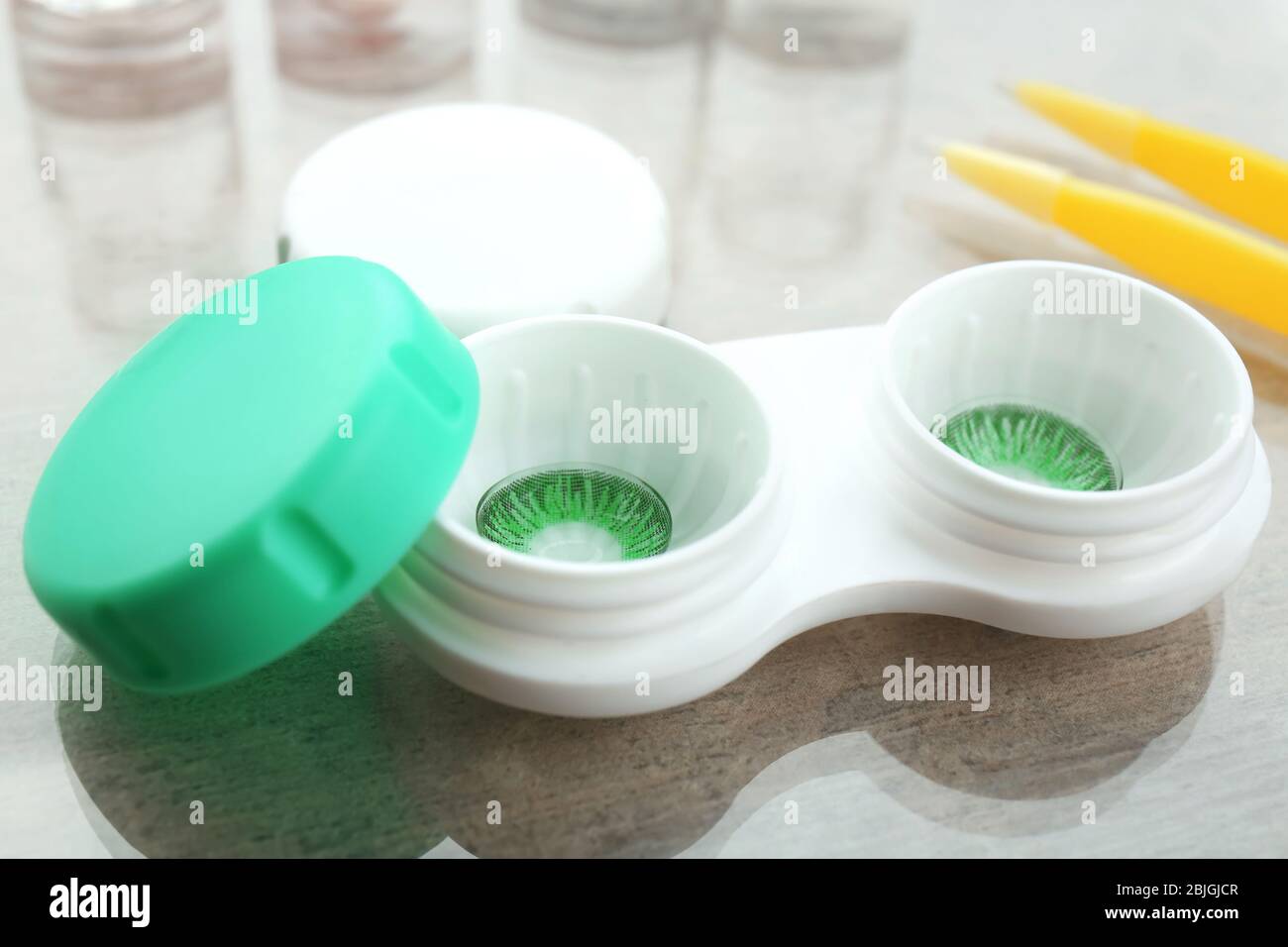 Container with color contact lenses on table Stock Photo - Alamy
