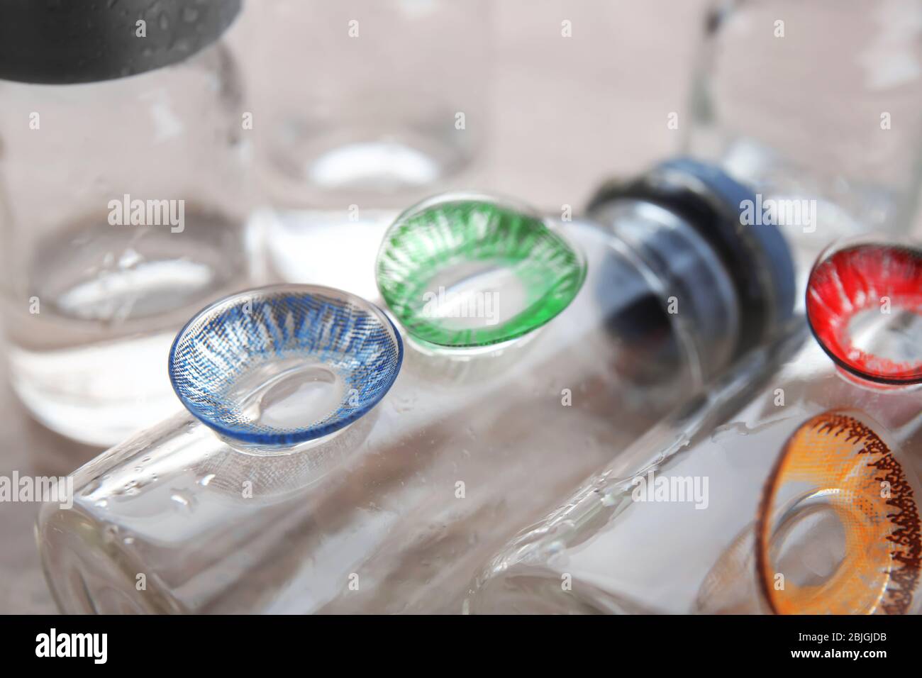 Bottles and color contact lenses on table Stock Photo - Alamy