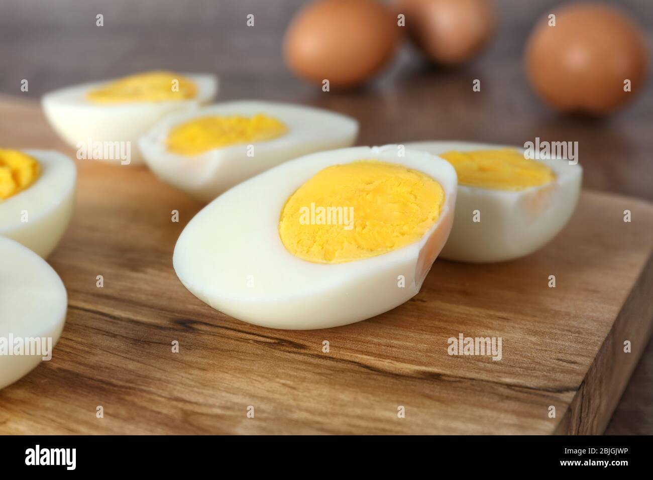 Cutting board with sliced hard boiled eggs, closeup. Nutrition concept Stock Photo - Alamy