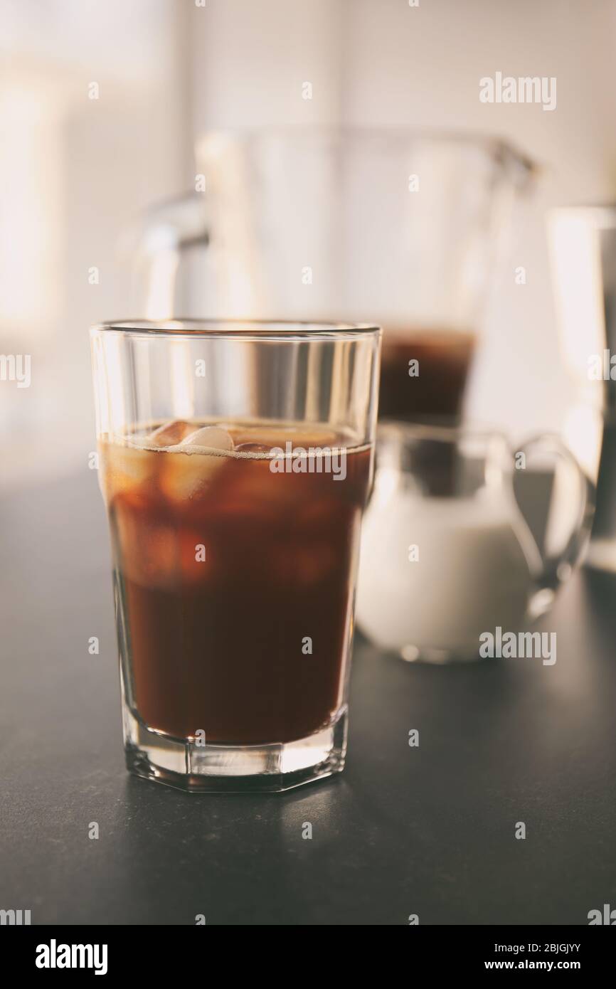 Glass of cold brew coffee on dark table Stock Photo - Alamy