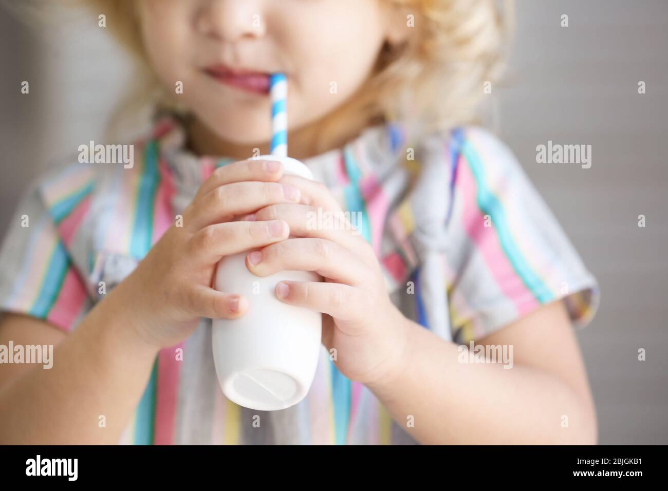 Cute little girl drinking yogurt at home, closeup Stock Photo - Alamy