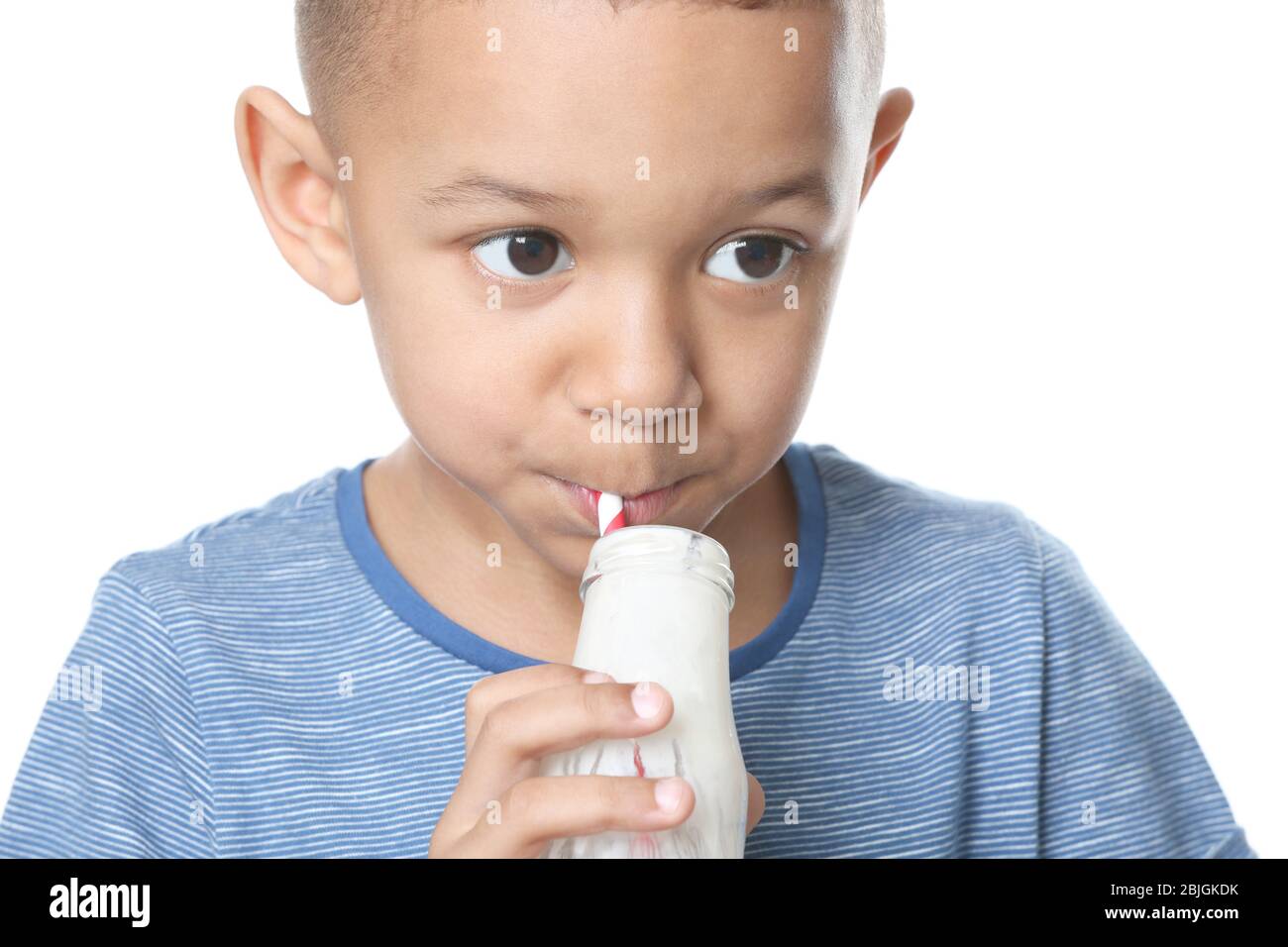 Cute African American boy drinking yogurt on white background, closeup ...