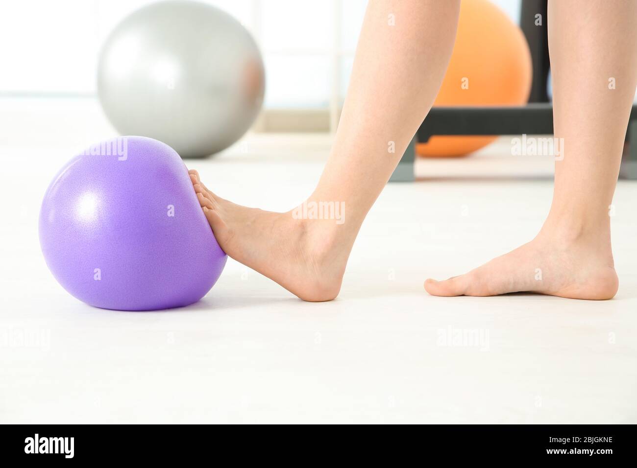Feet of woman doing exercises with rubber ball in clinic Stock Photo ...