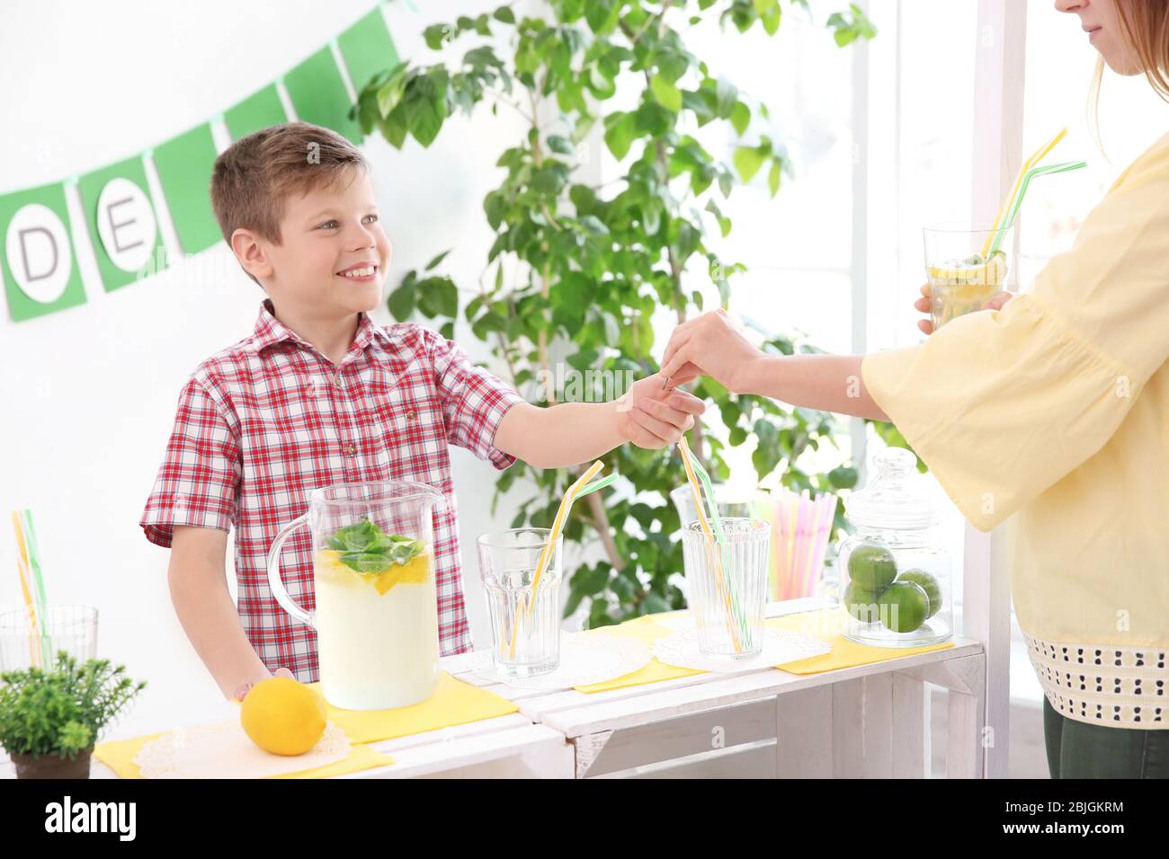 Cute little boy selling lemonade at counter Stock Photo - Alamy