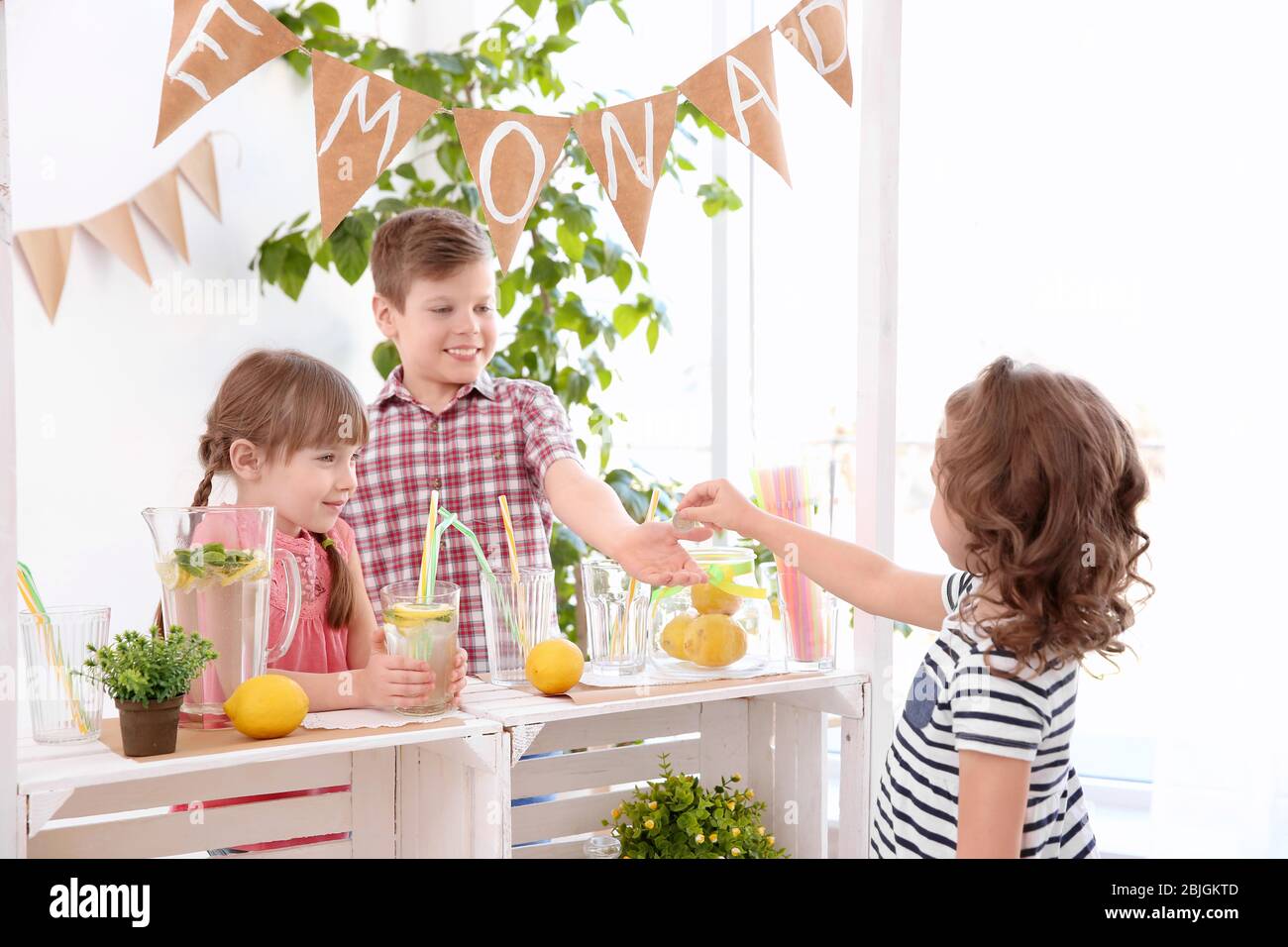 Cute little kids selling lemonade at counter Stock Photo - Alamy