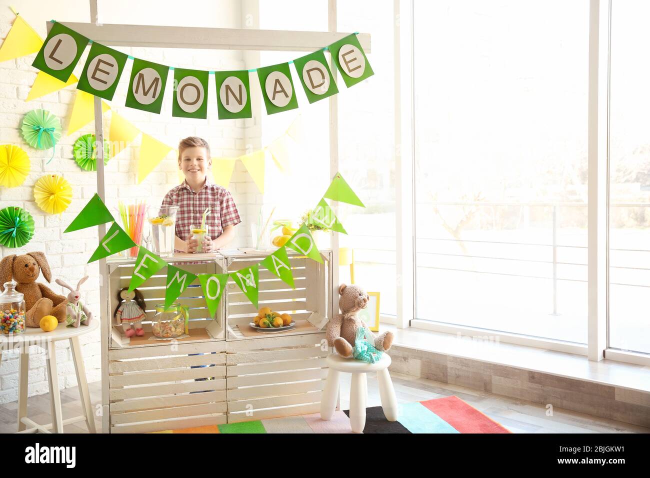 Cute little boy selling lemonade at counter Stock Photo - Alamy
