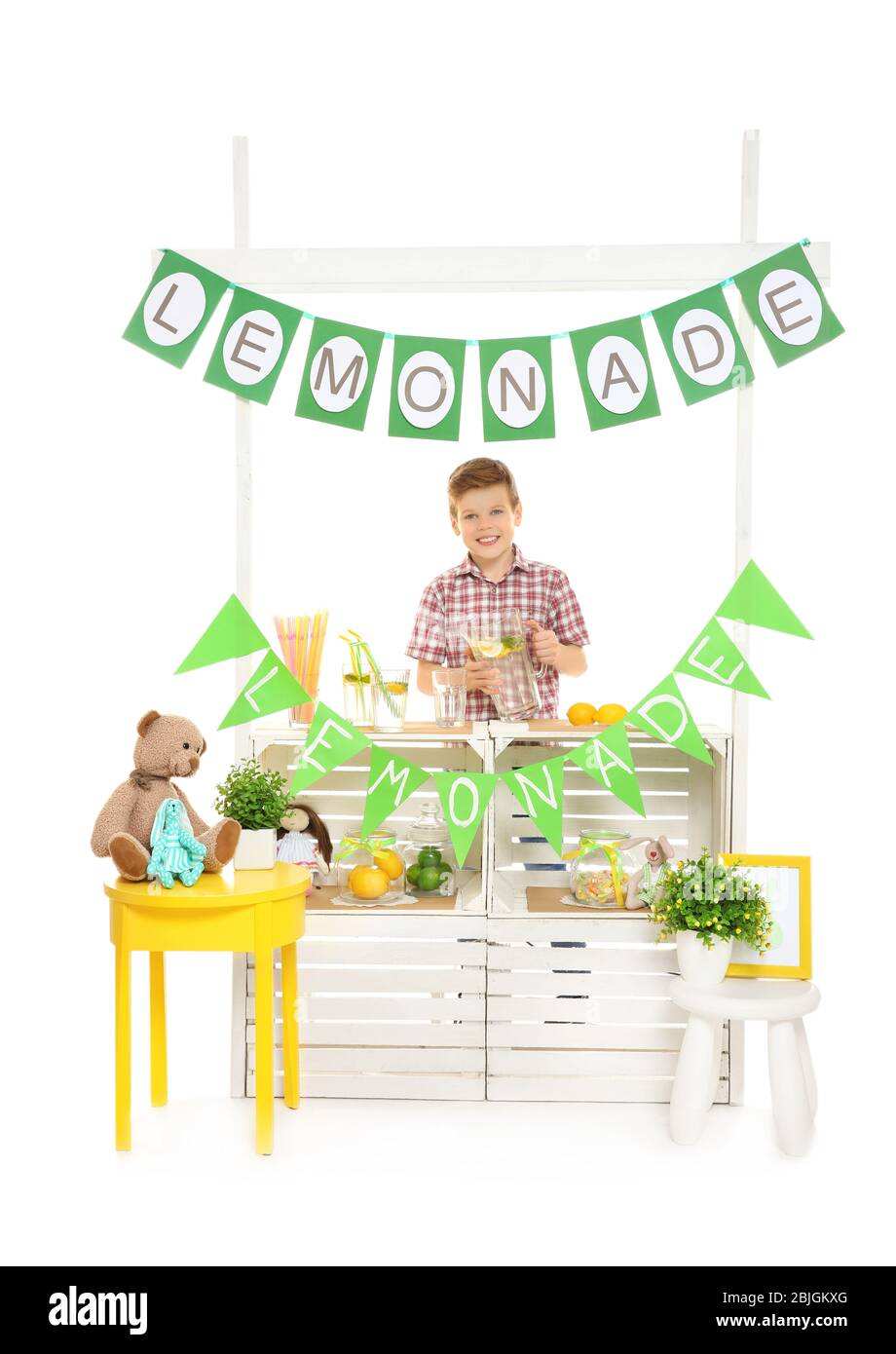 Cute little boy selling lemonade at counter on white background Stock ...
