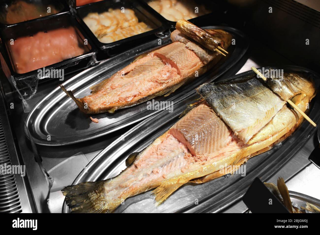 Tray with smoked fish in supermarket Stock Photo - Alamy