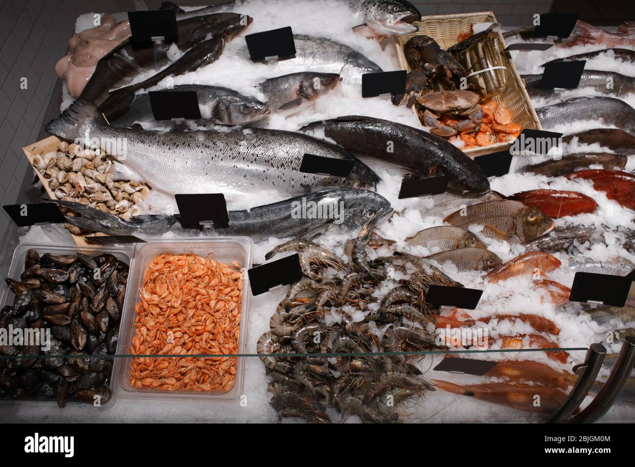 Fresh fish and other seafood in supermarket Stock Photo - Alamy