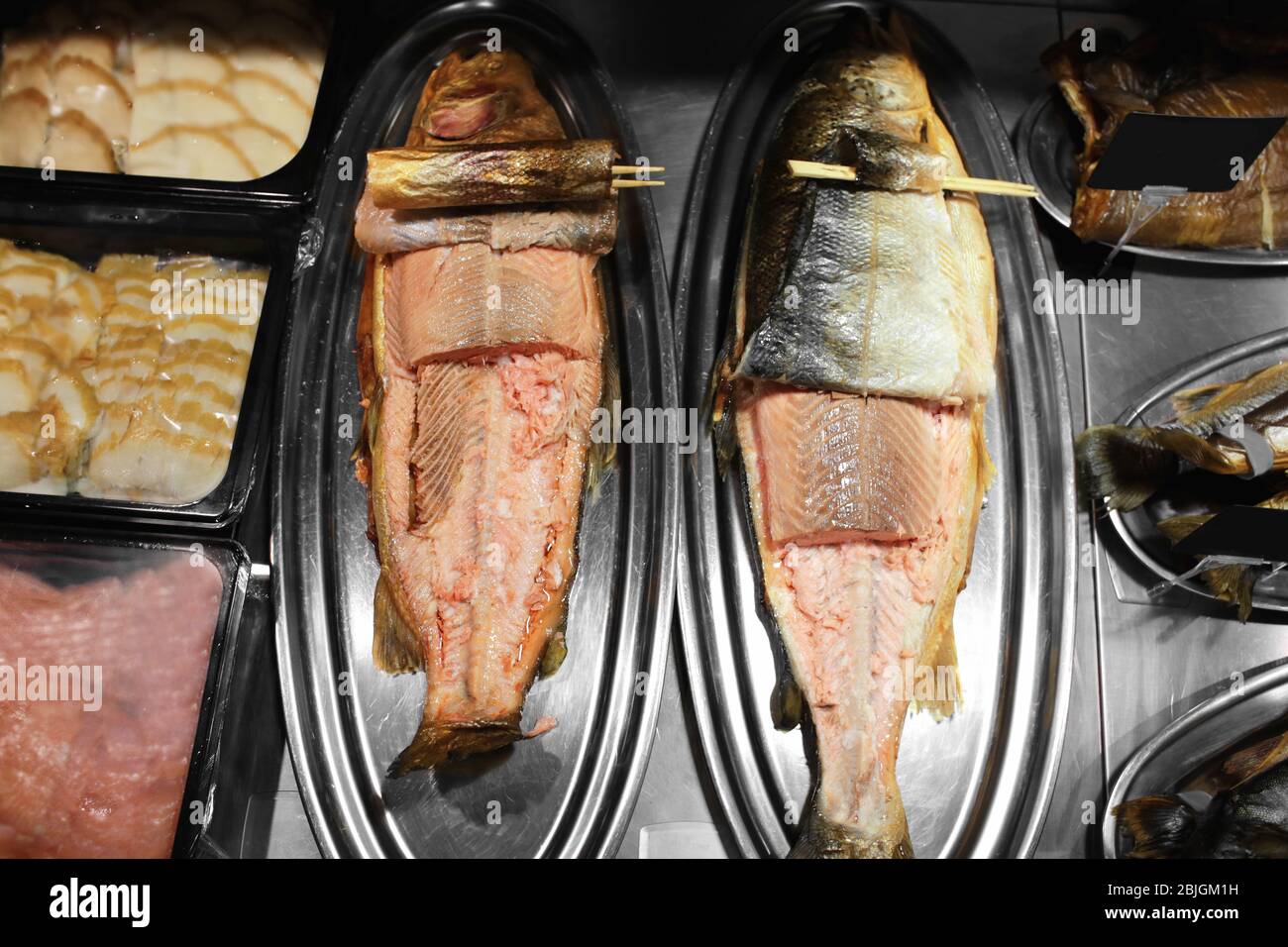 Tray with smoked fish in supermarket Stock Photo - Alamy