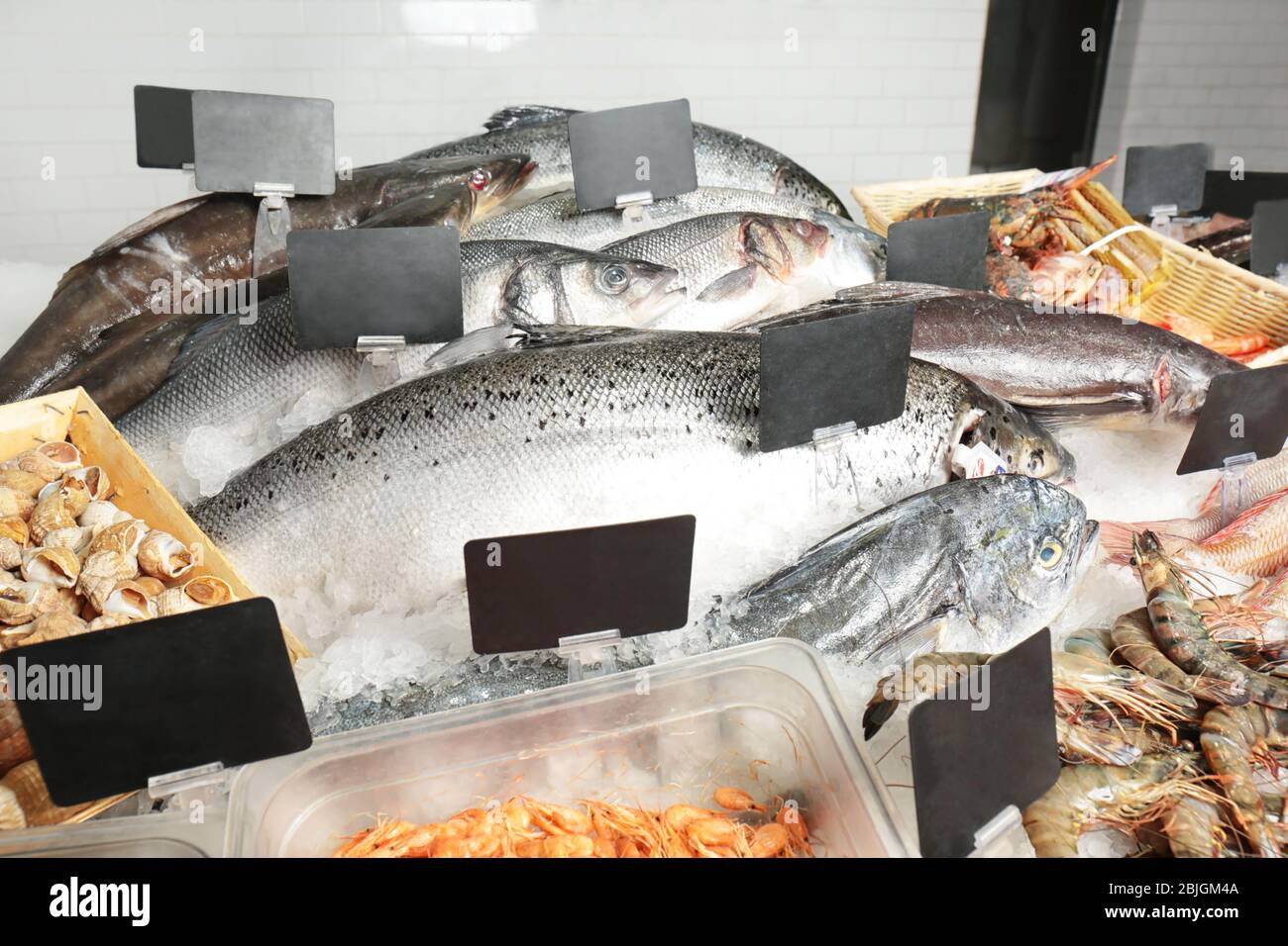Fresh fish and other seafood in supermarket Stock Photo - Alamy