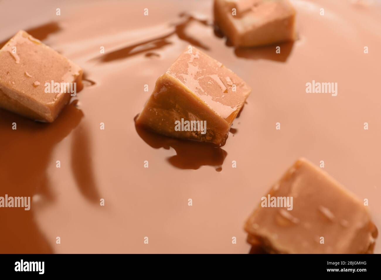 Tasty caramel sauce and candies, closeup Stock Photo - Alamy