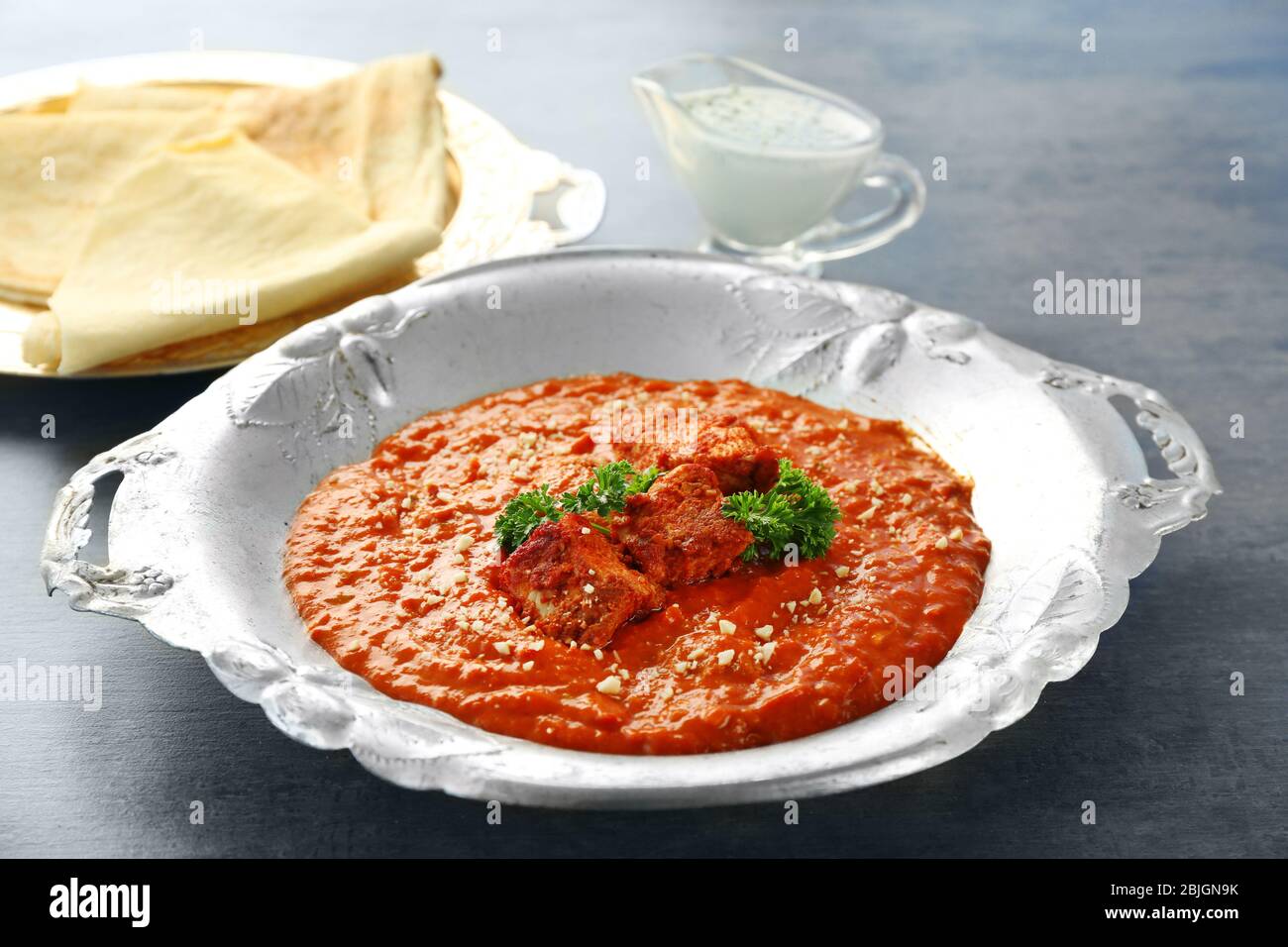 Delicious Murgh Makhani in metalic plate on table Stock Photo - Alamy