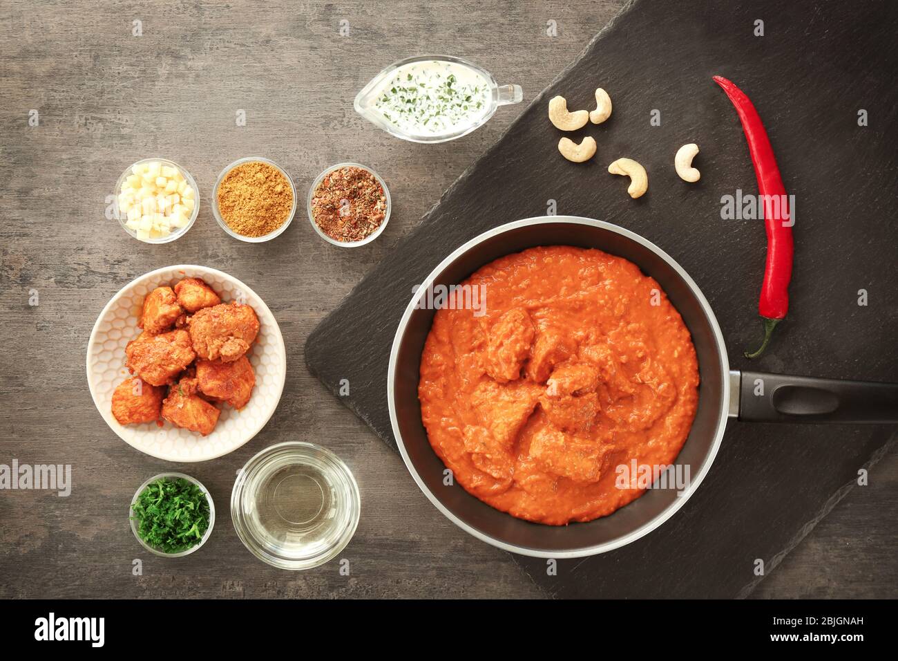 Murgh Makhani in frying pan with ingredients on table Stock Photo - Alamy