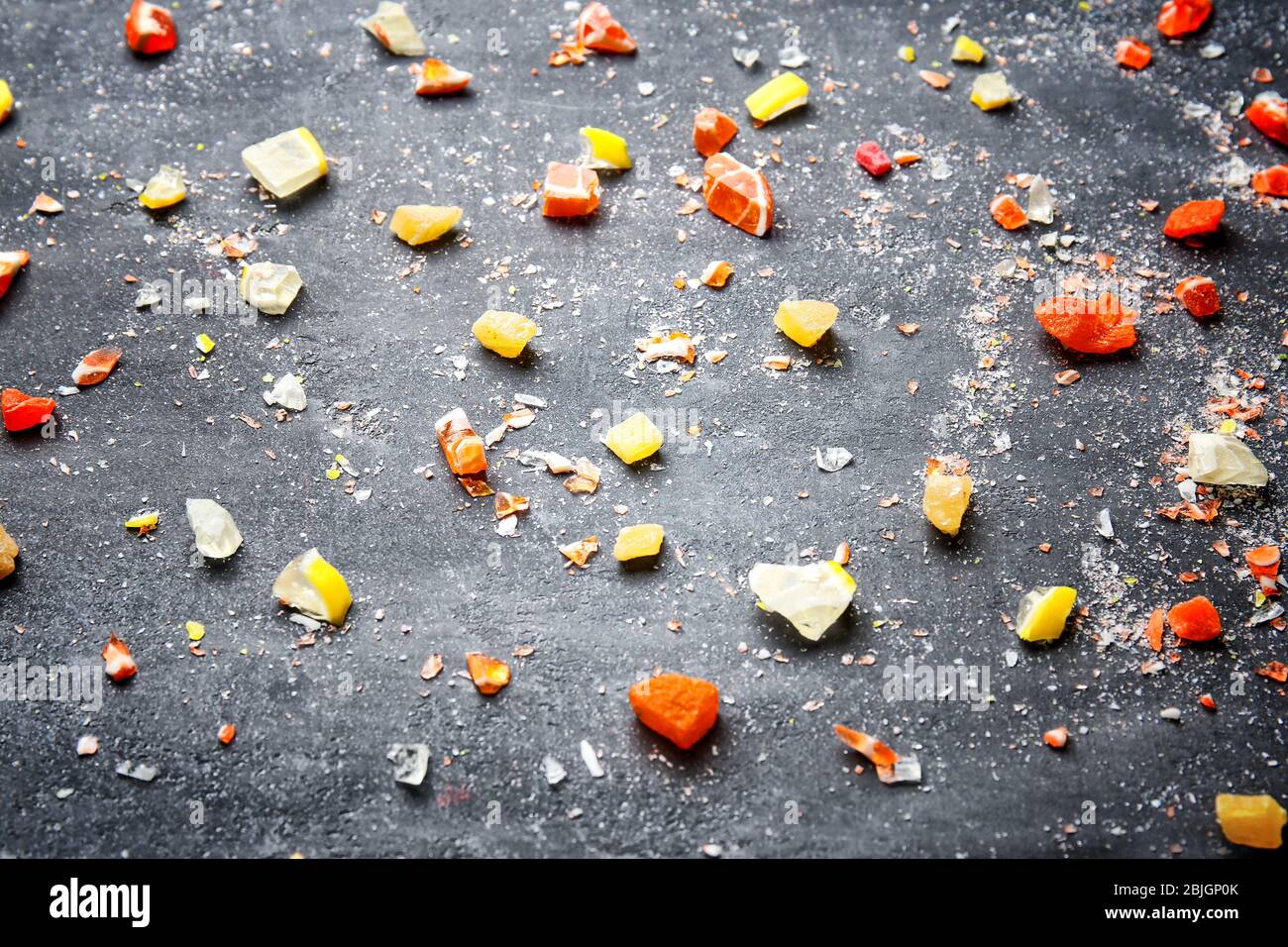 Delicious broken candies on grey background Stock Photo - Alamy