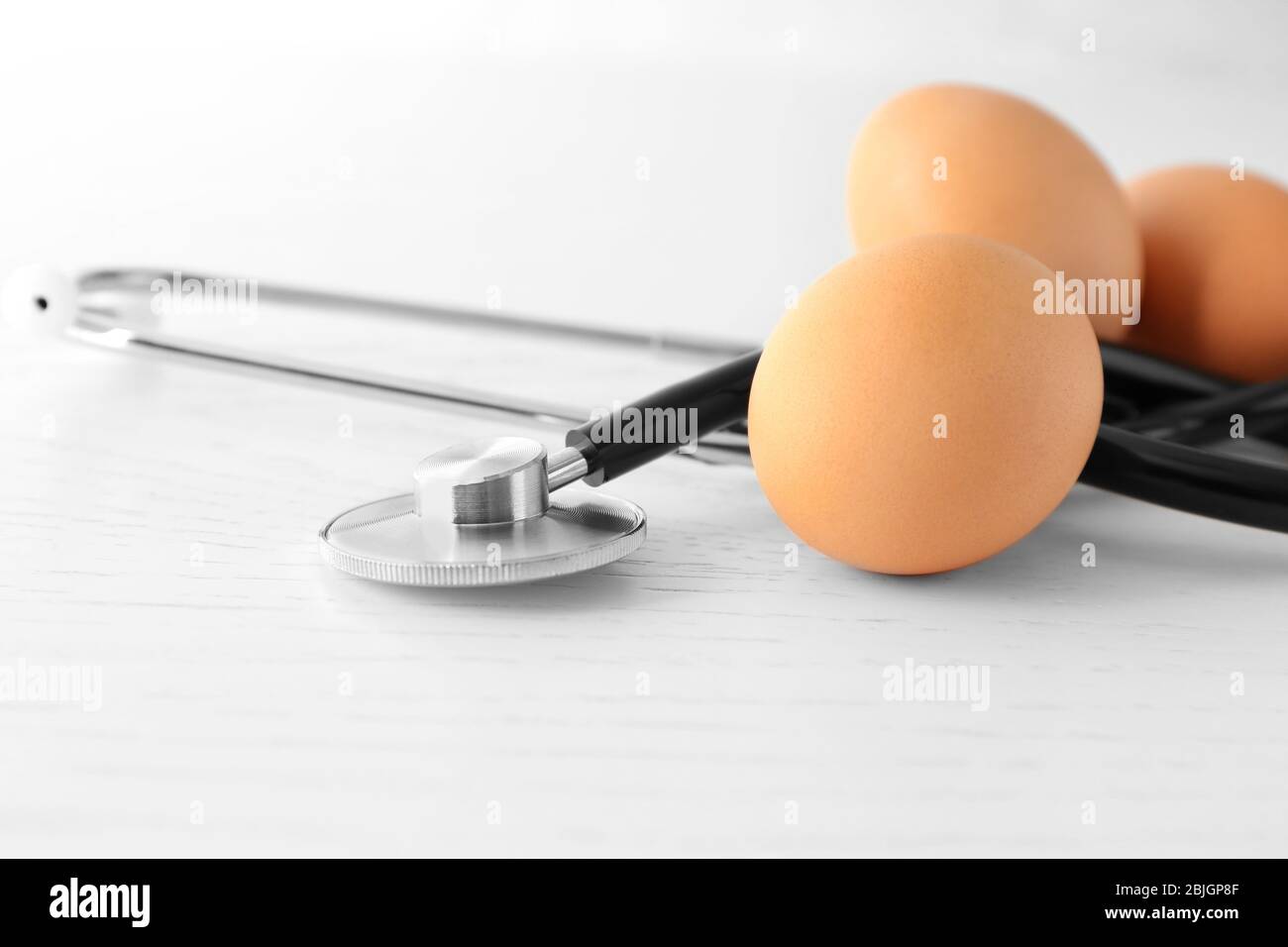Eggs with stethoscope on table. Nutrition concept Stock Photo - Alamy