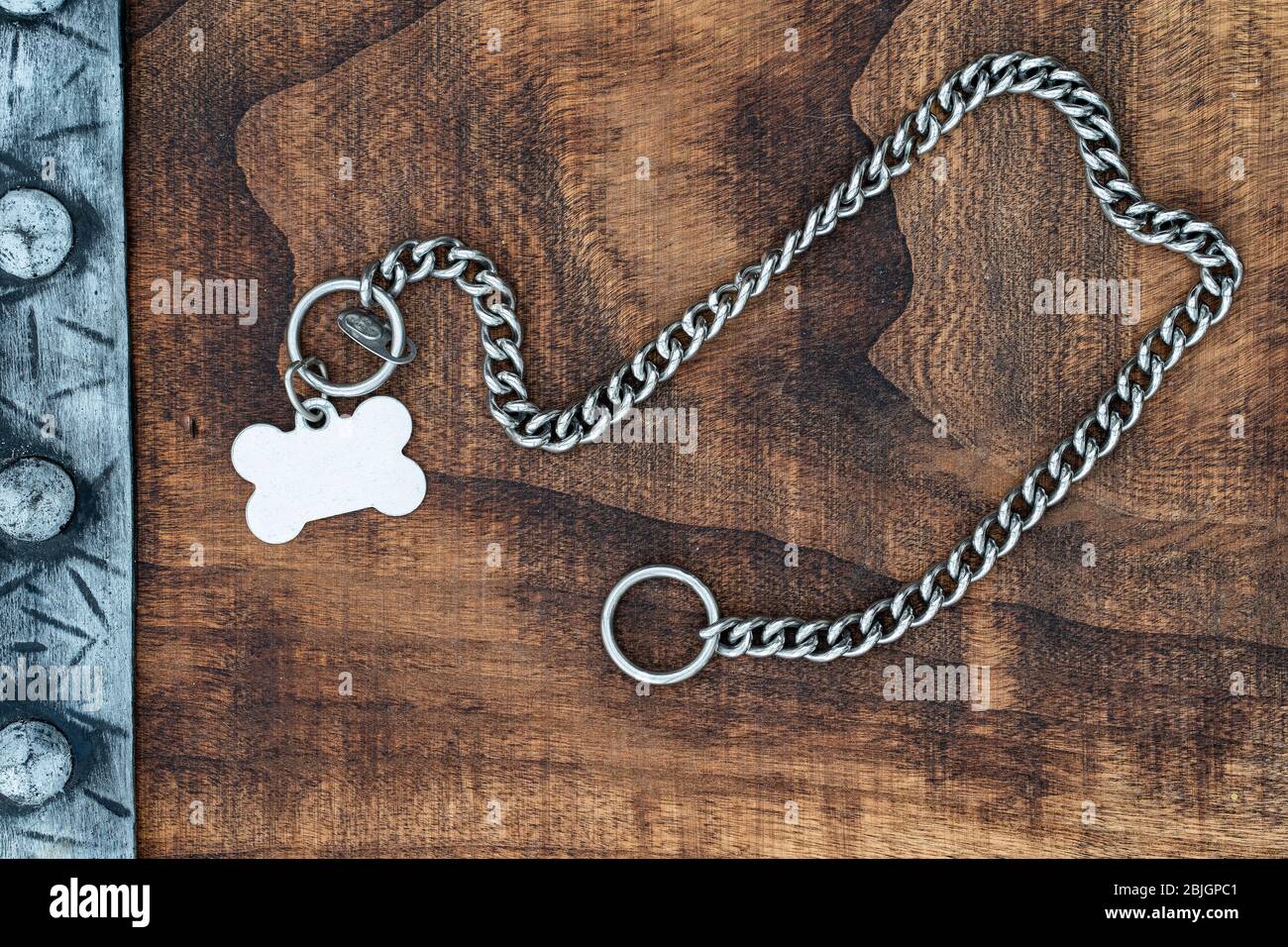 punched medieval belt on a wood background with medal for dog and space ...