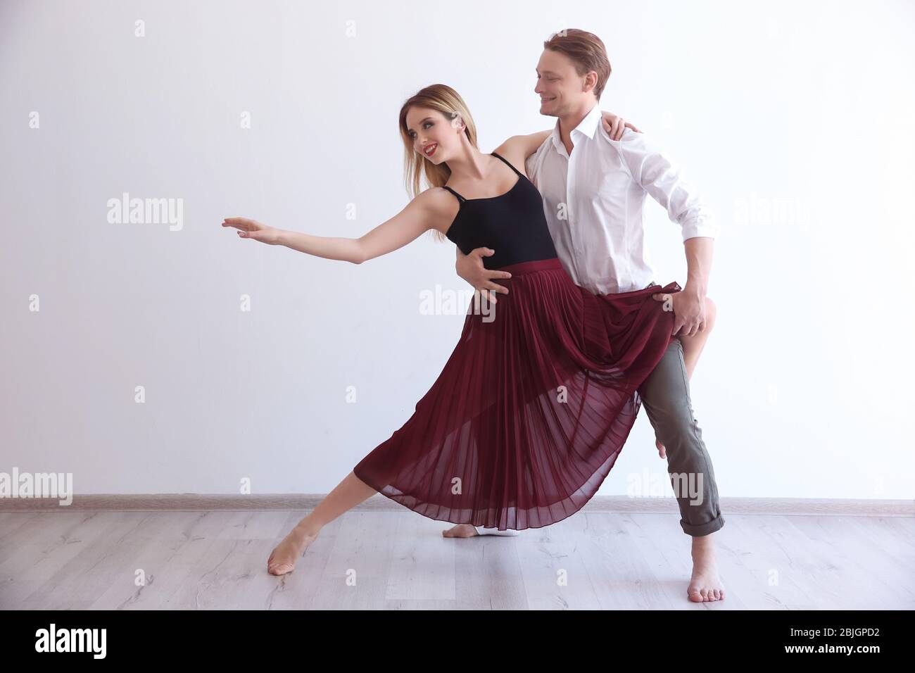 Beautiful young couple in dance studio Stock Photo - Alamy