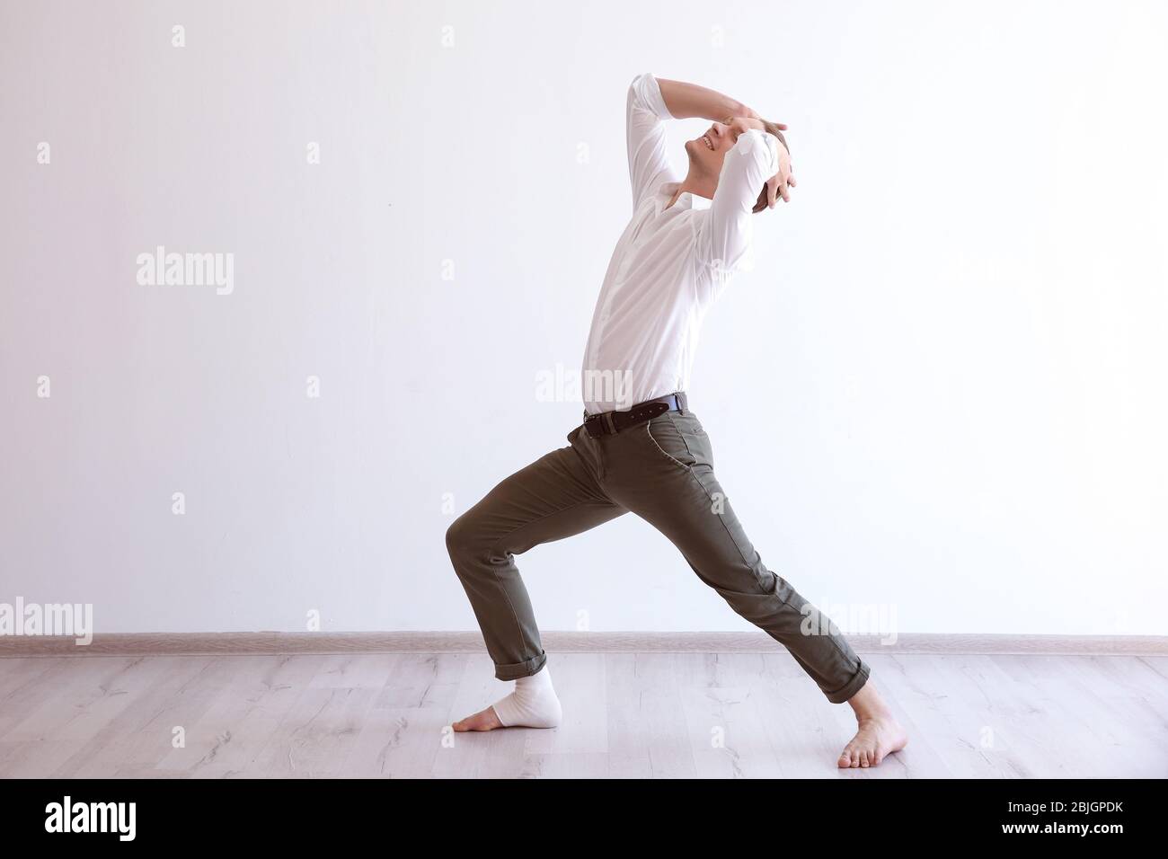Handsome young man in dance studio Stock Photo - Alamy
