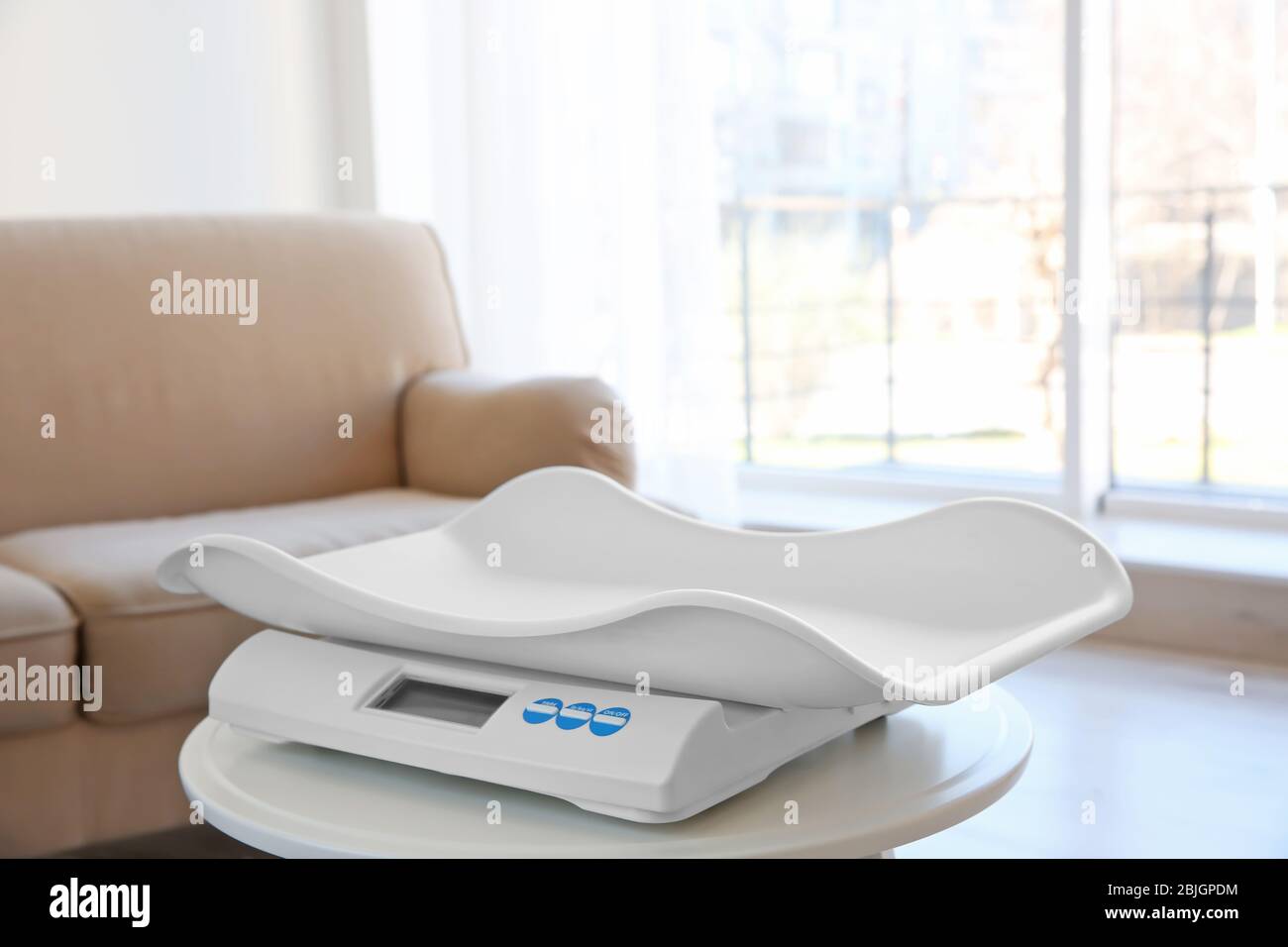 Modern baby scales on table in room Stock Photo - Alamy