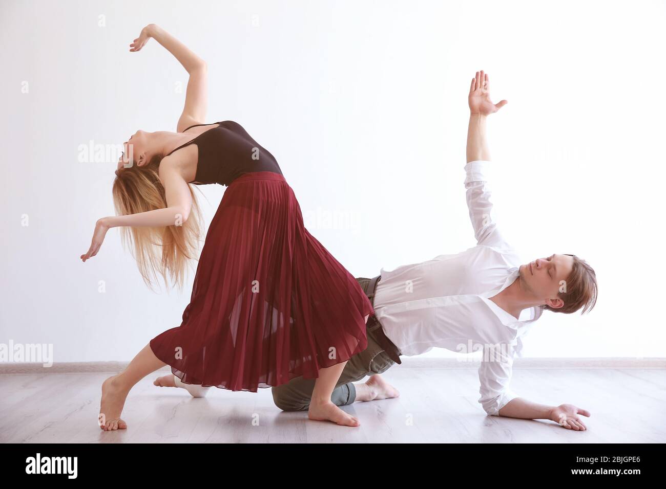 Beautiful young couple in dance studio Stock Photo - Alamy