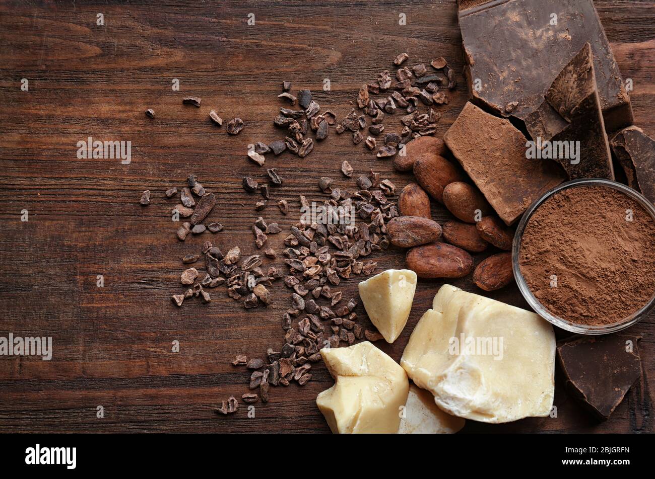 Composition of cocoa products on wooden table Stock Photo - Alamy