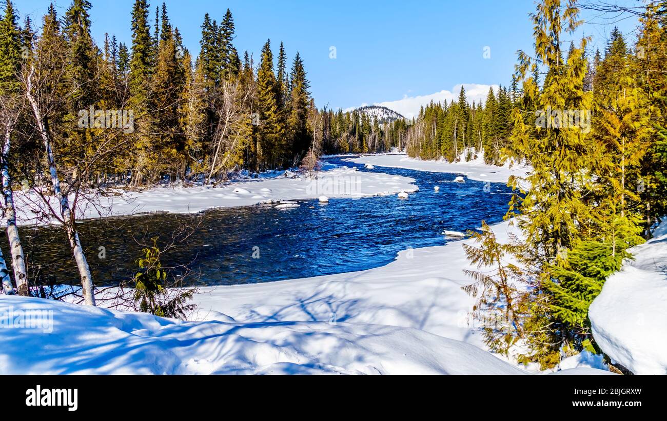Snow and ice lining the Murtle River in winter time in the Cariboo ...
