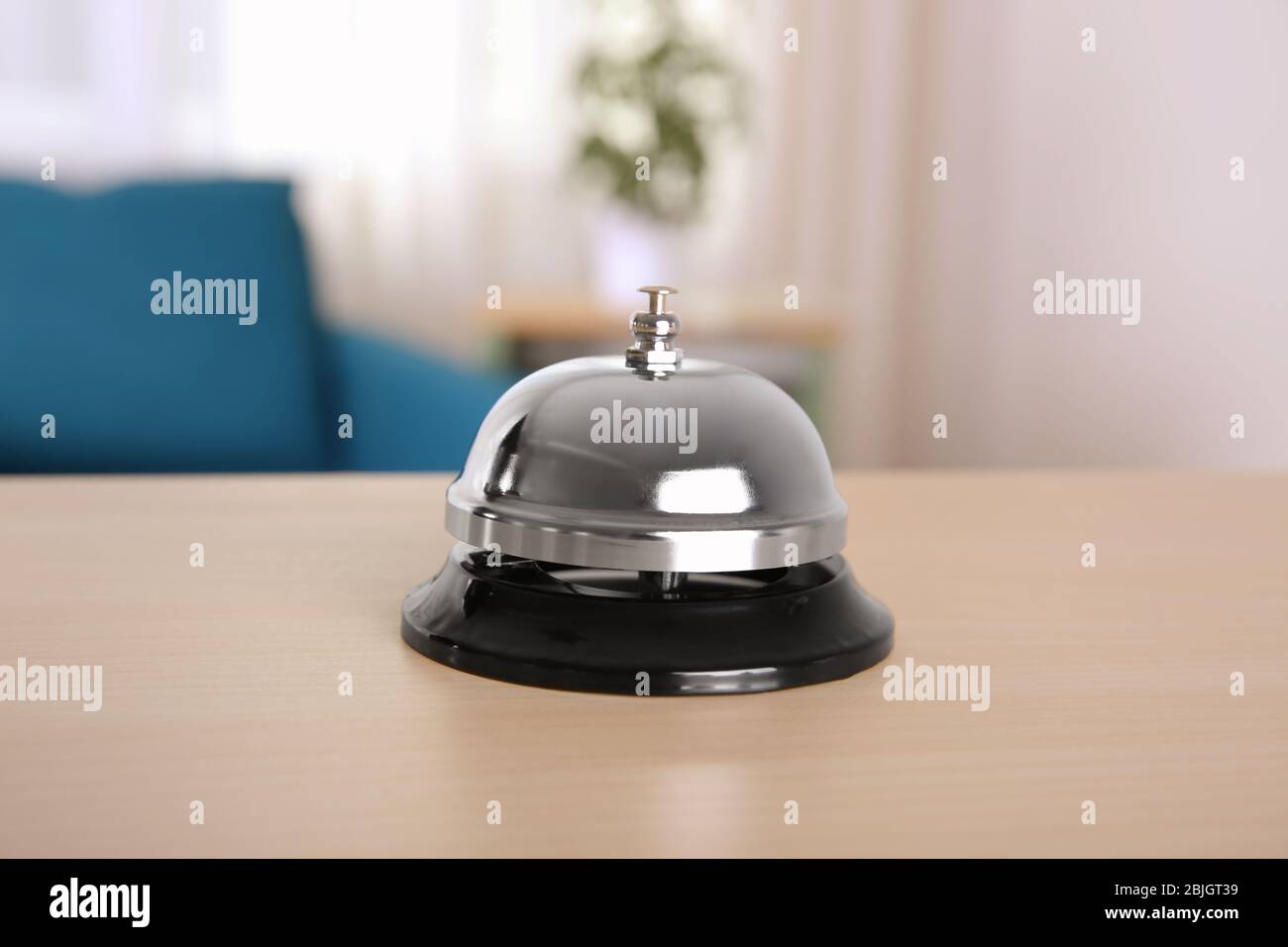 Silver service bell on reception desk Stock Photo - Alamy