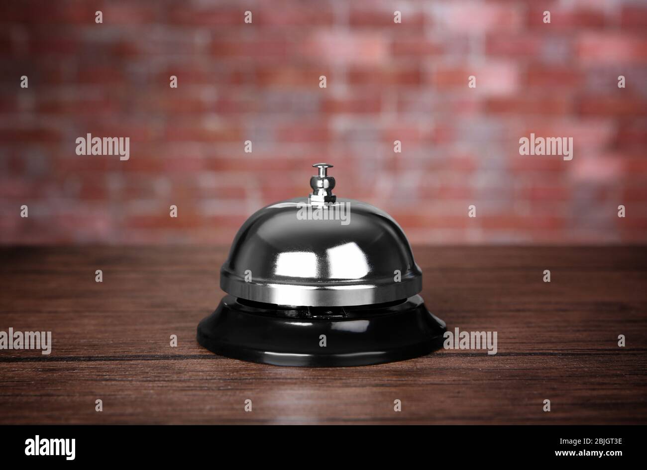 Silver service bell on reception desk Stock Photo - Alamy