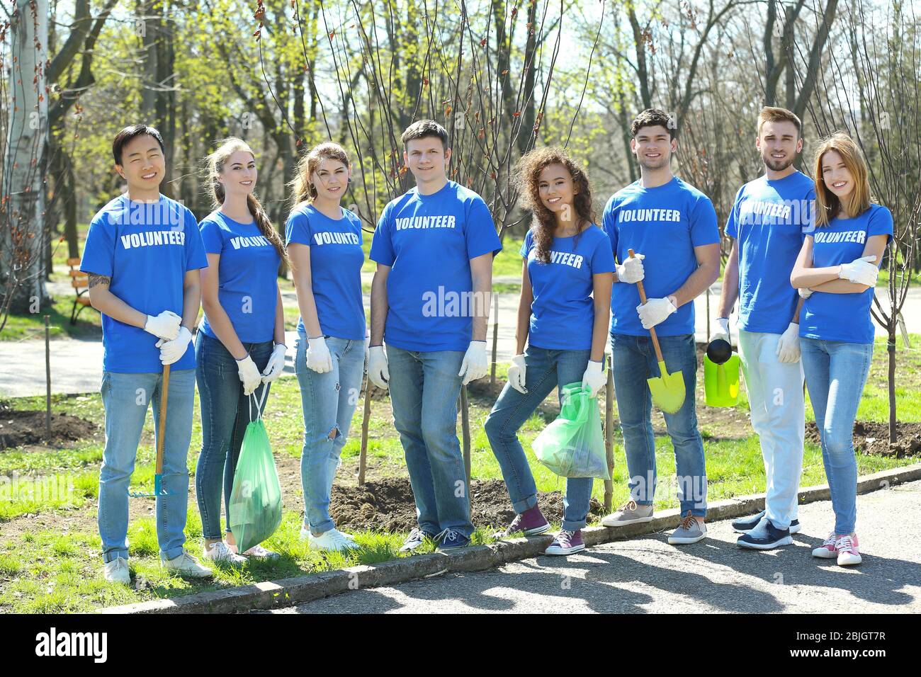 Group of volunteers in park on sunny day Stock Photo - Alamy