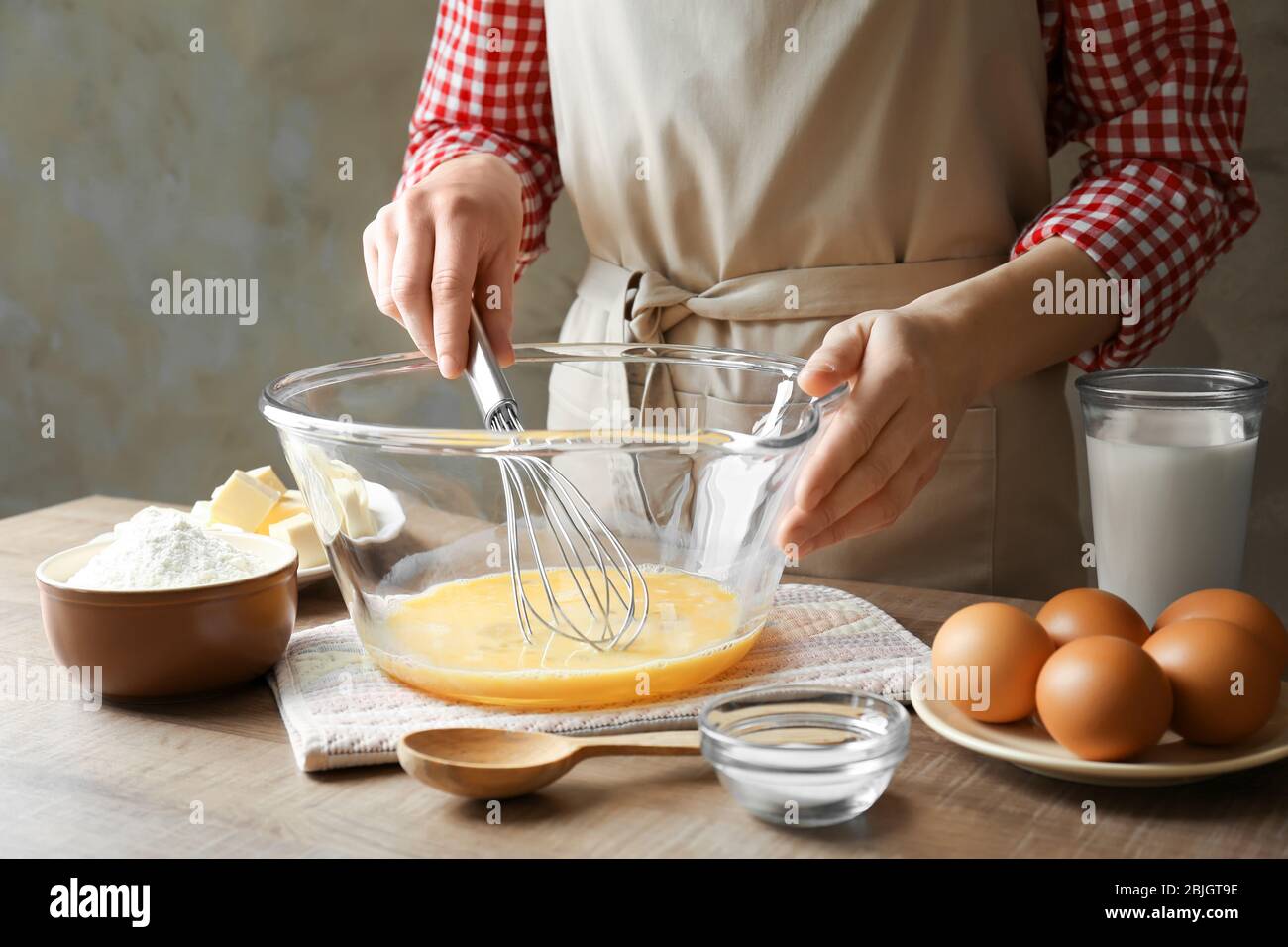 Woman making dough for a pie in bowl on table Stock Photo - Alamy