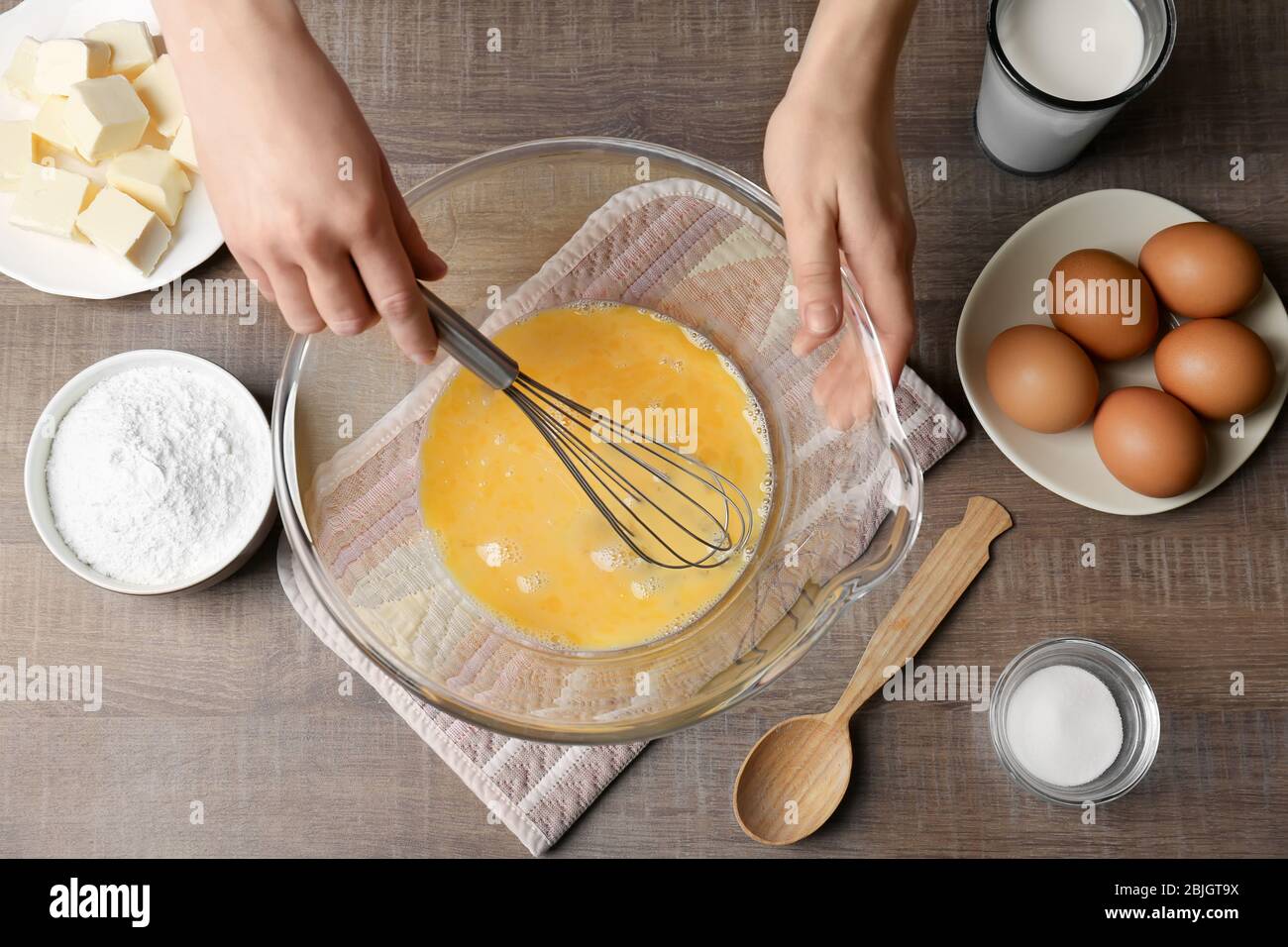 Woman making dough for a pie in bowl on table Stock Photo - Alamy