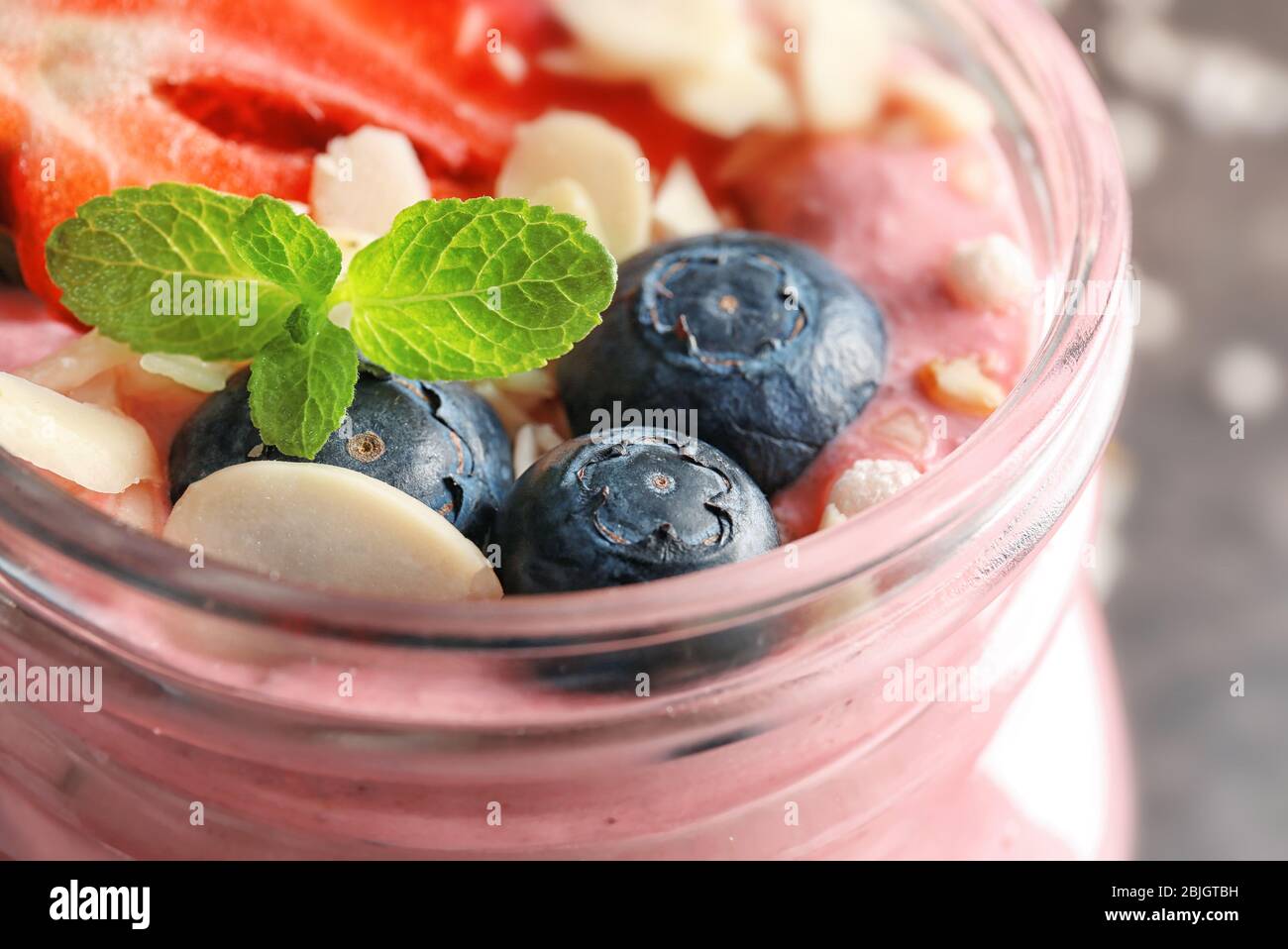 Delicious parfait with fruits in jar, closeup Stock Photo - Alamy